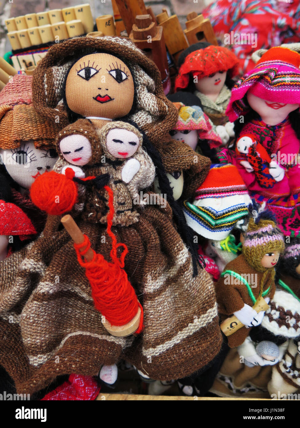 Peruvian hand made doll woolen fabric background Stock Photo - Alamy