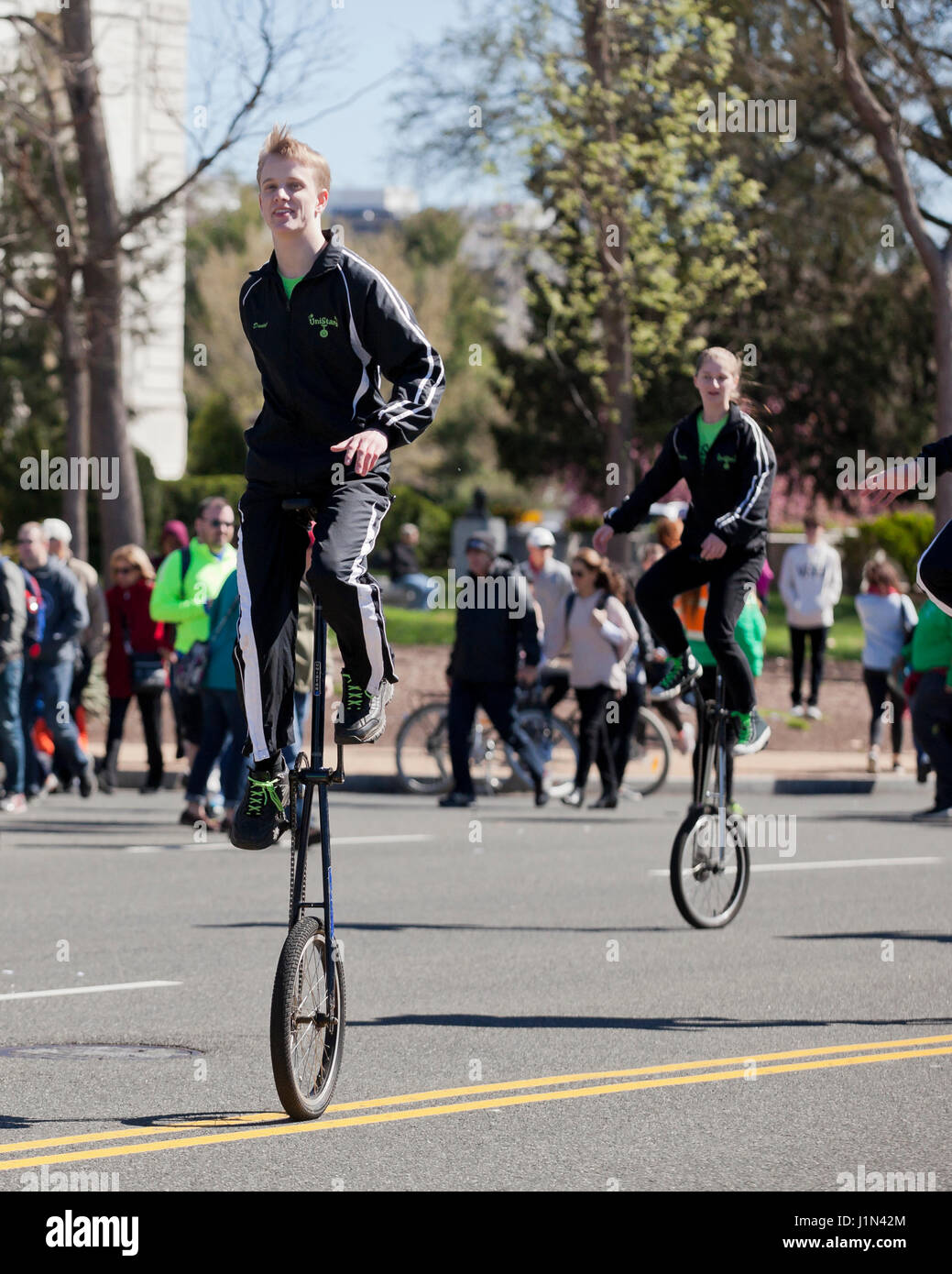 Unicycle riders (unicyclists) at cultural festival street festival ...