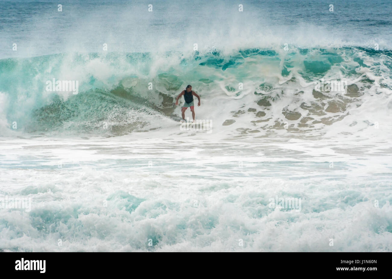 A surfer rides a barrel wave at Tunnels Beach, Kauai, Hawaii Stock ...