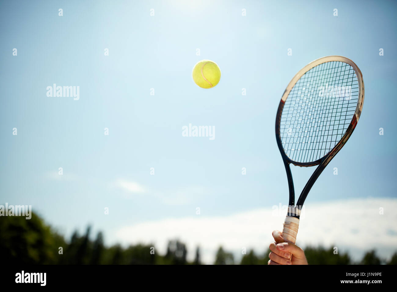Close up of tennis racket and ball in air Stock Photo - Alamy