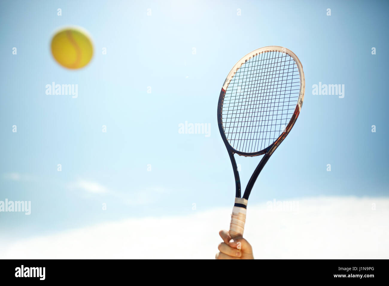 Close up of tennis racket and ball up in action Stock Photo - Alamy
