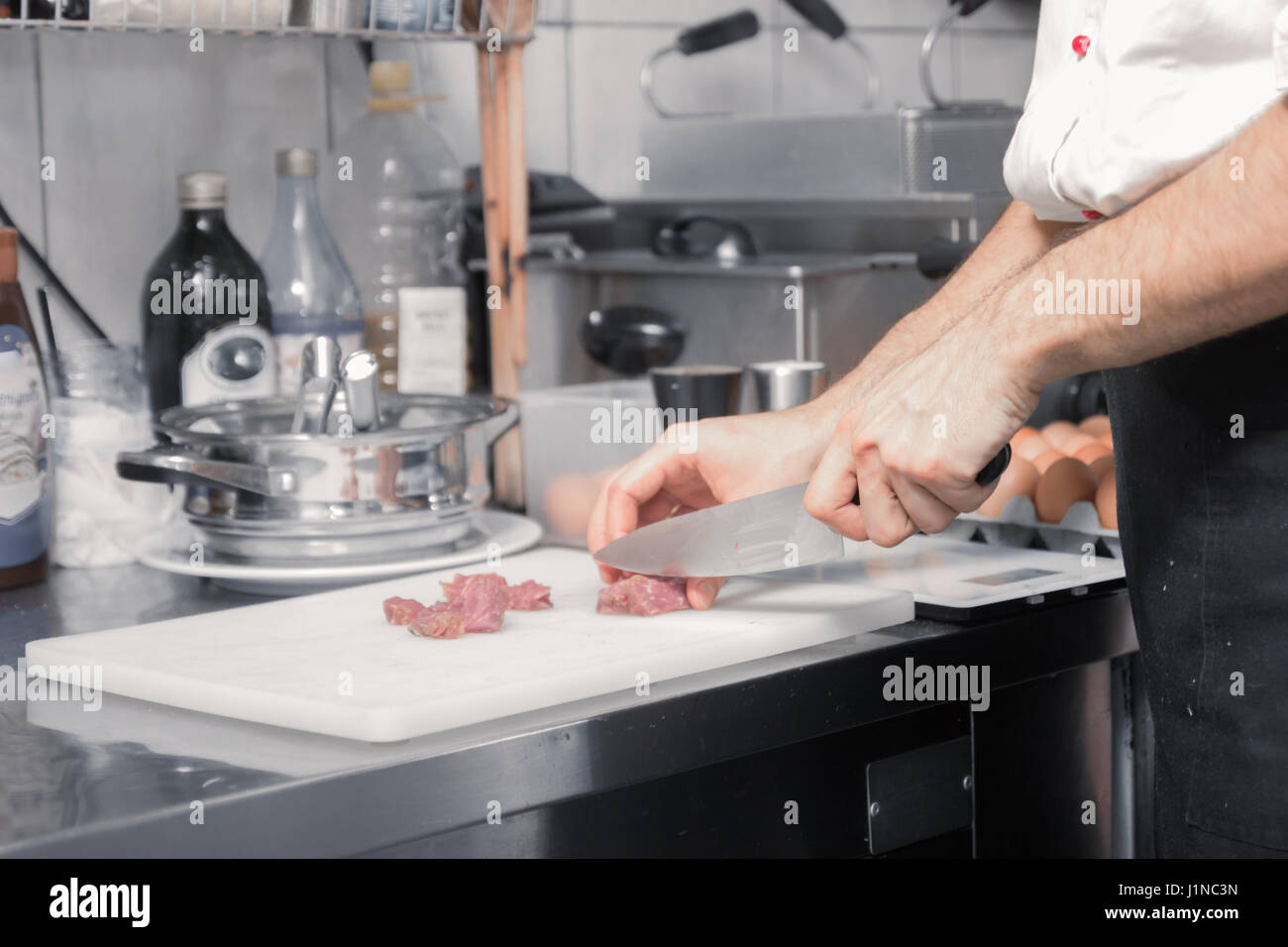 Cutting raw meat hi-res stock photography and images - Alamy