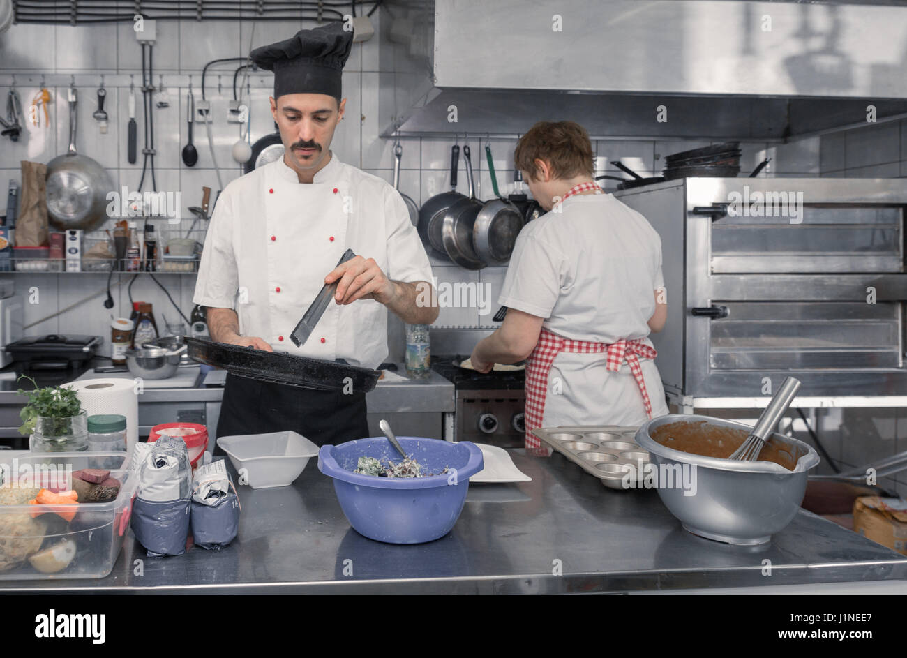 two people, chef assistant cooking food, commercial kitchen Stock Photo ...