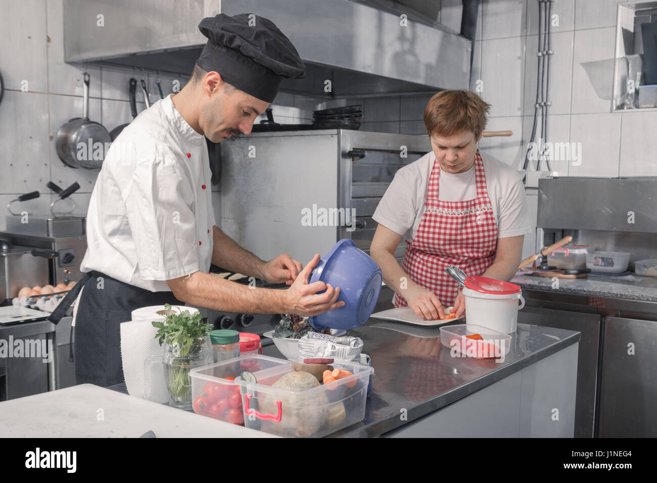 two people, chef assistant cooking salad food, commercial kitchen Stock ...