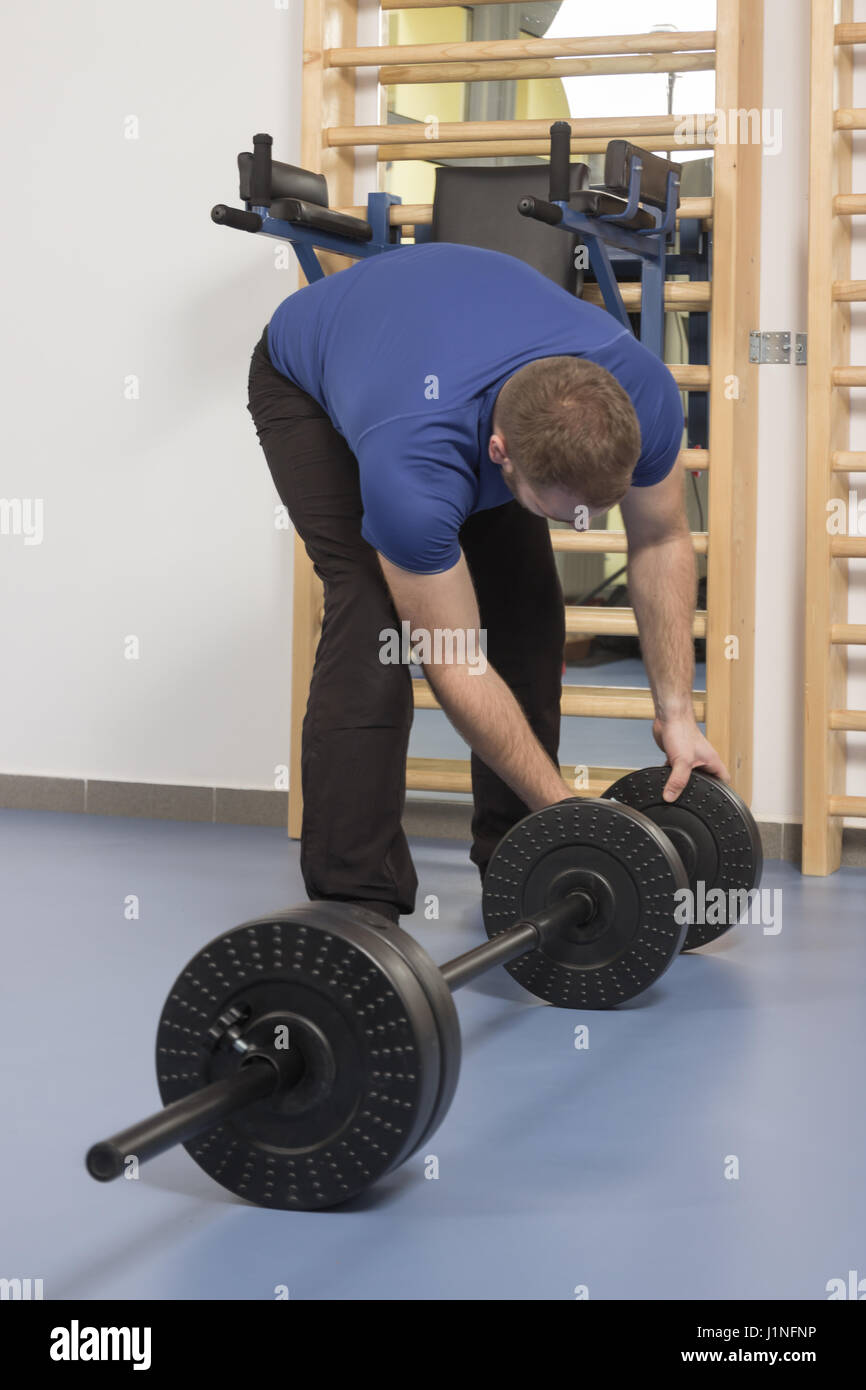 one young adult man only, setting up, weight bar, weights Stock Photo ...