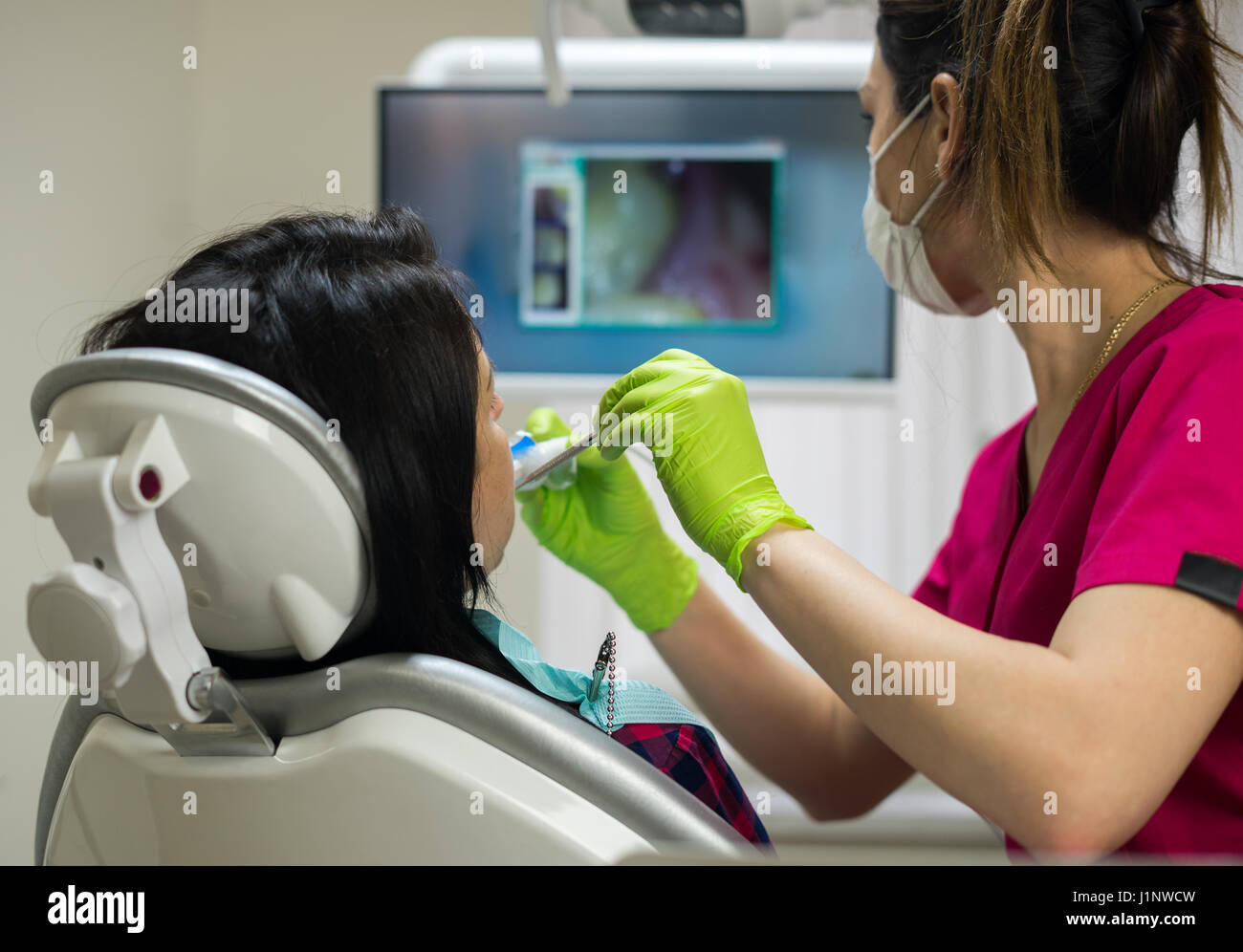 Dentist examining woman's teeth with camera Stock Photo - Alamy