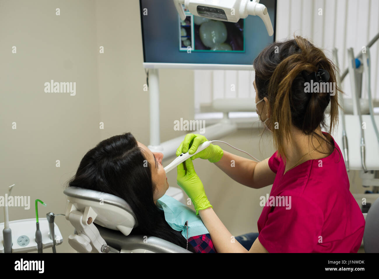 Dentist examining woman's teeth with camera Stock Photo - Alamy