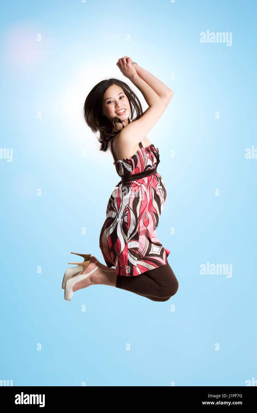 A beautiful asian woman jumping for joy Stock Photo - Alamy