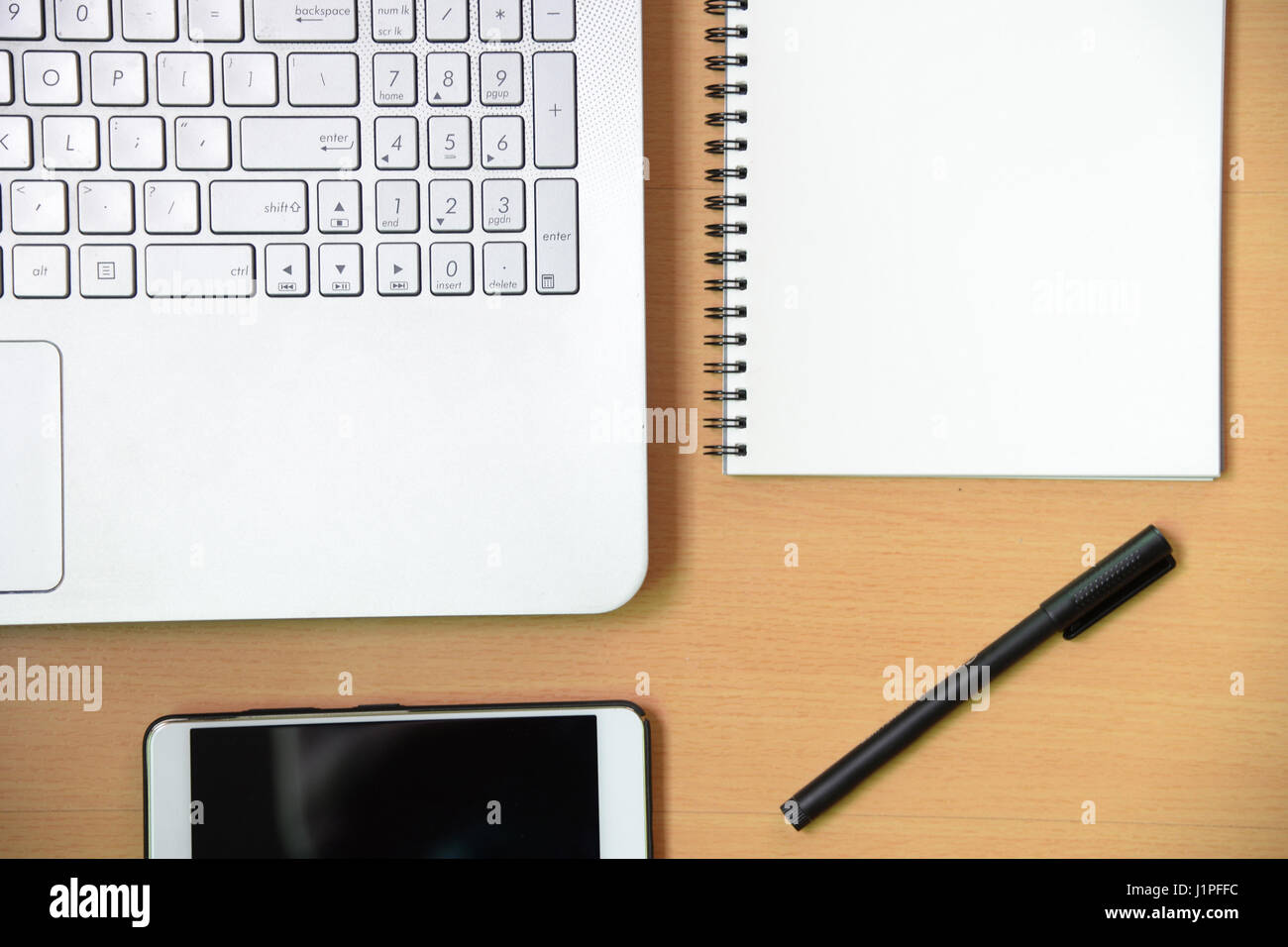 computer notebook with smartphone notebook message and a pen on working ...