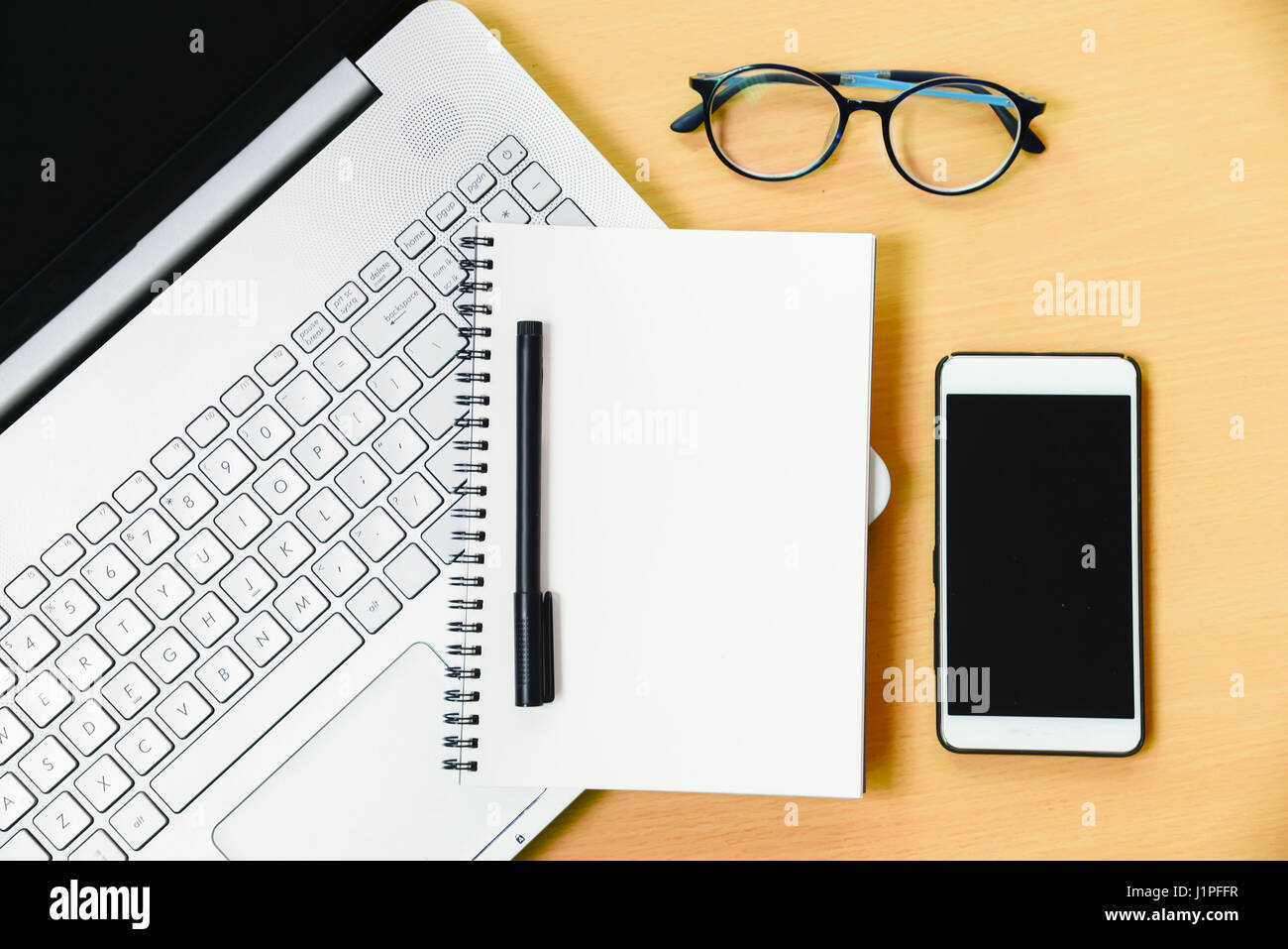 computer notebook with smartphone notebook message and a pen on working ...