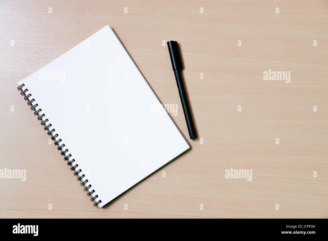 notebook paper note with a pen on wooden desk Stock Photo - Alamy