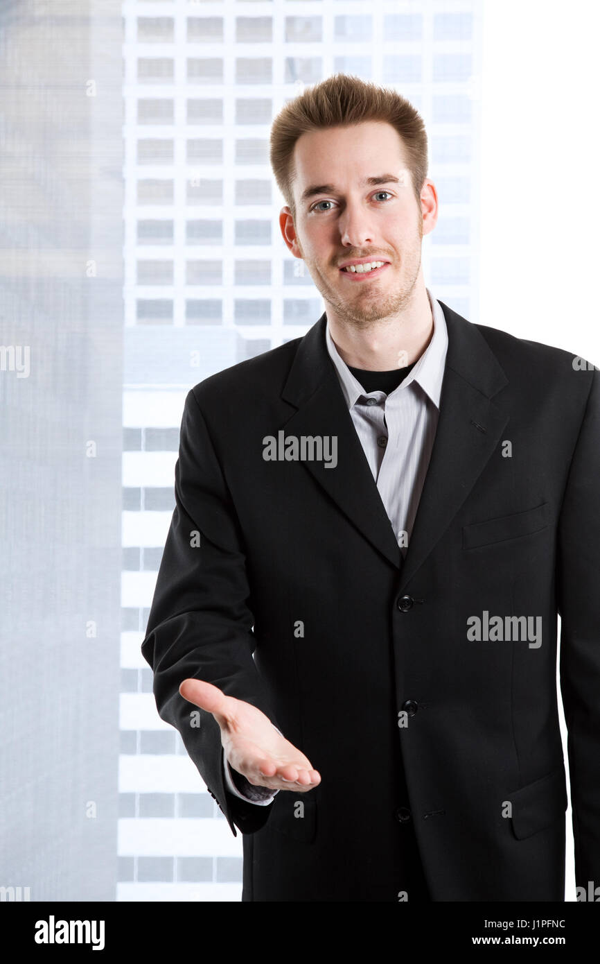 A caucasian businessman offering a handshake in the office Stock Photo ...