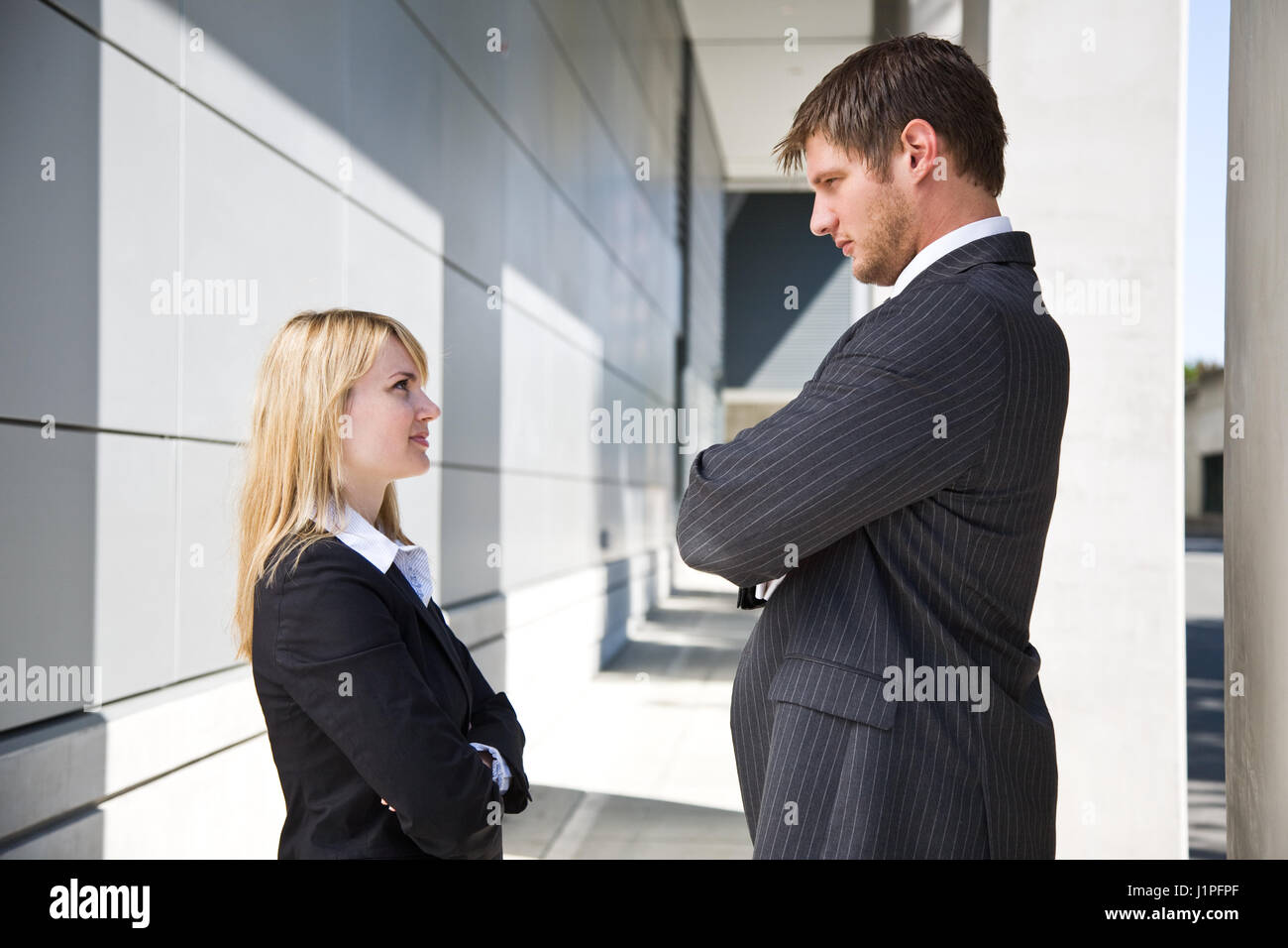 Two caucasian business people looking at each other angrily Stock Photo ...