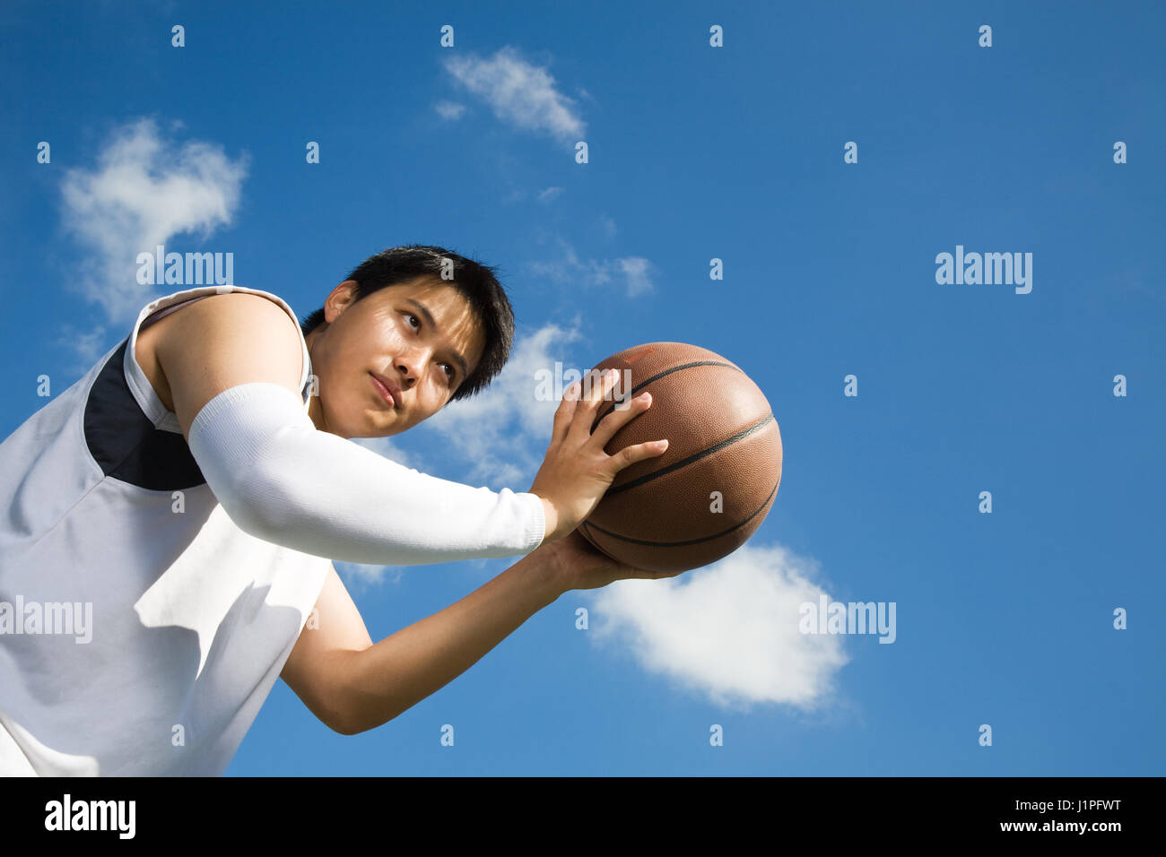 A young asian basketball player shooting a basketball Stock Photo - Alamy