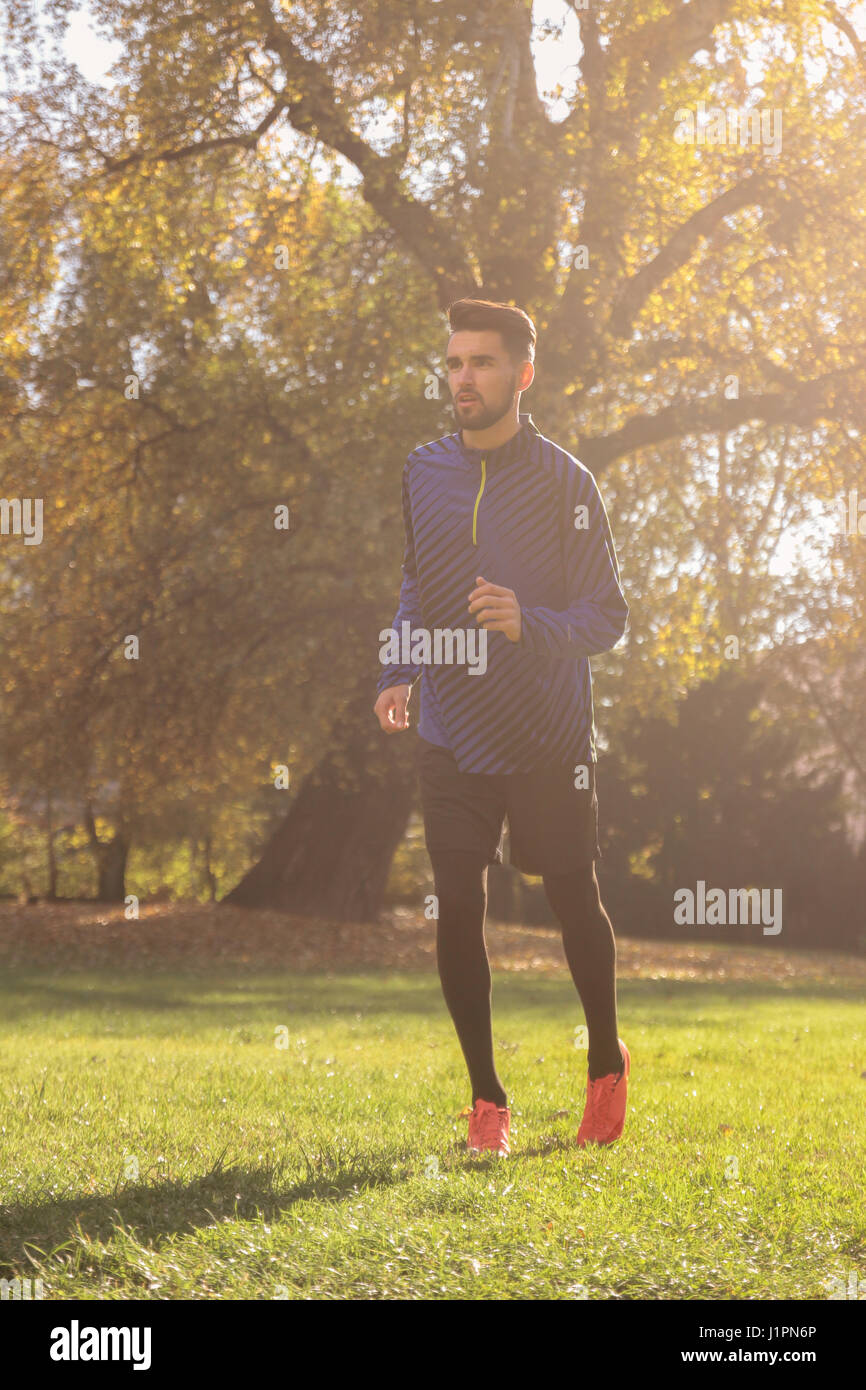 young man athlete, football player, footballer, sport clothes, park ...