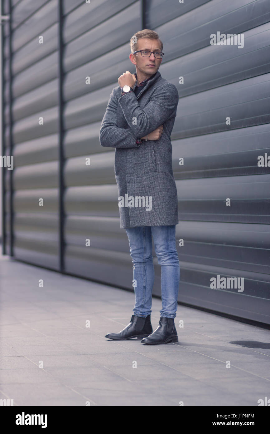 young man posing, architecture wall, good looking clothes, looking ...