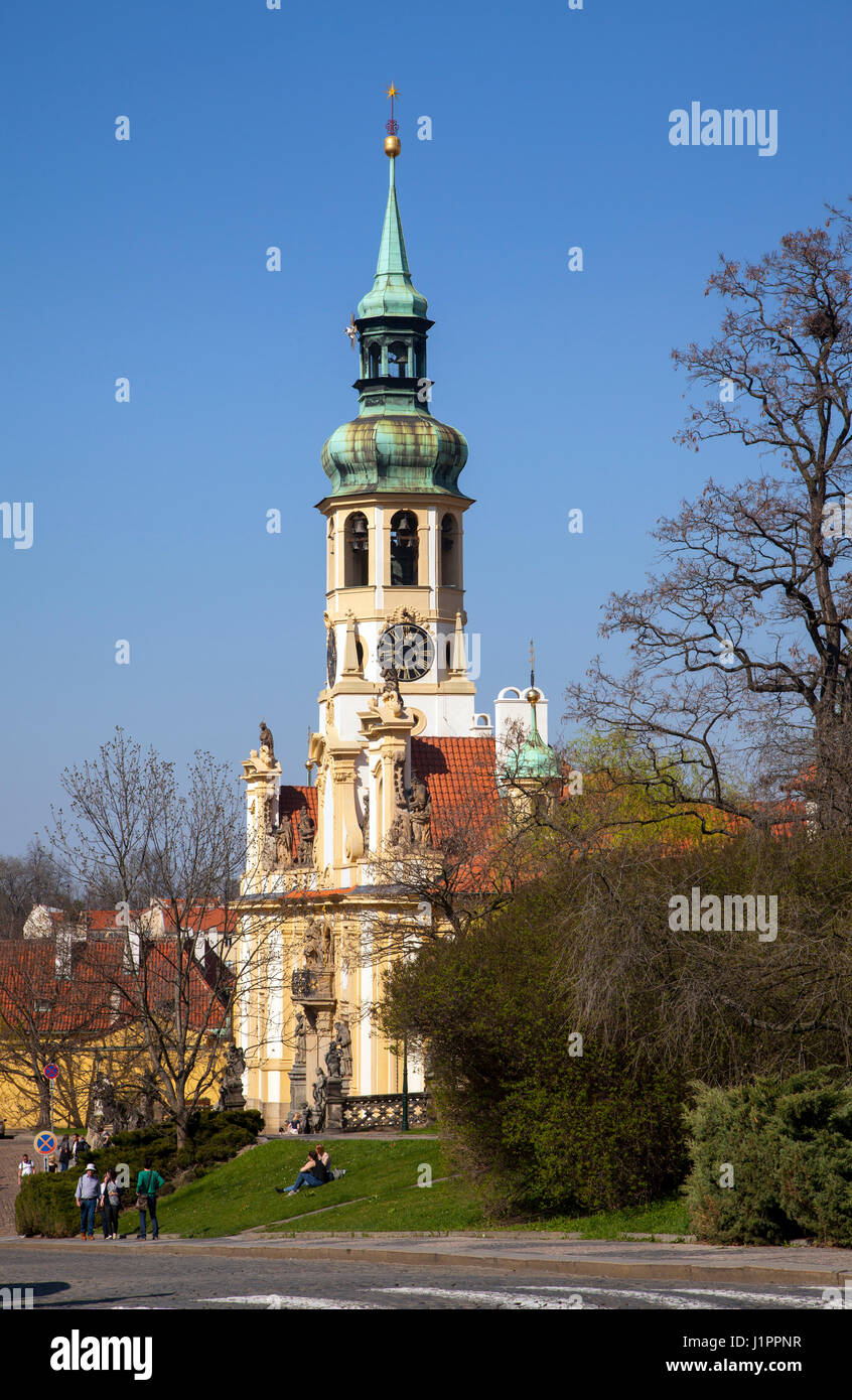 Street vendor in The Loreta square Prague with the Loreta church in the ...