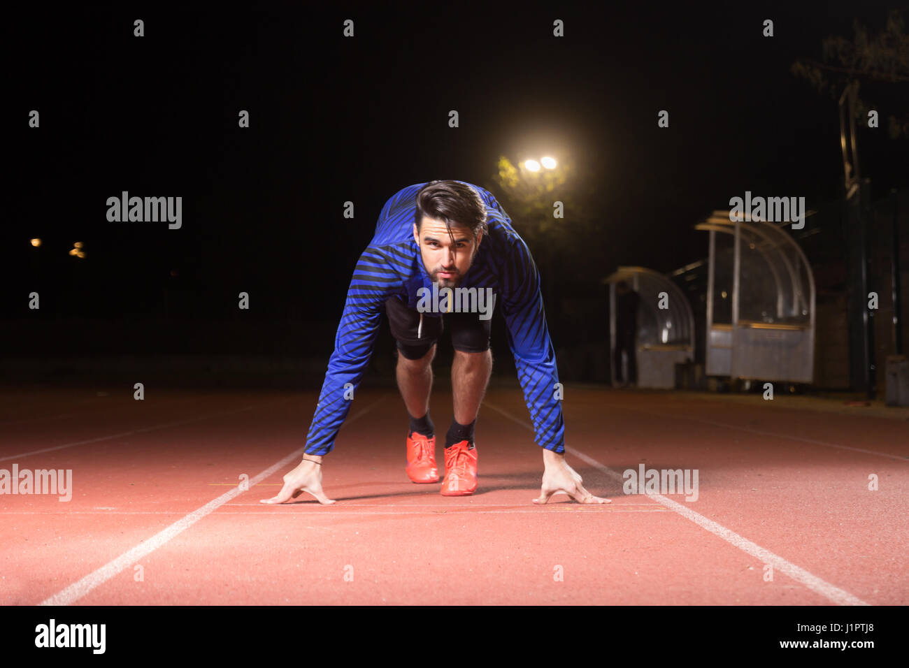 Young adult man, athlete, runner, sprinter, start position, running ...