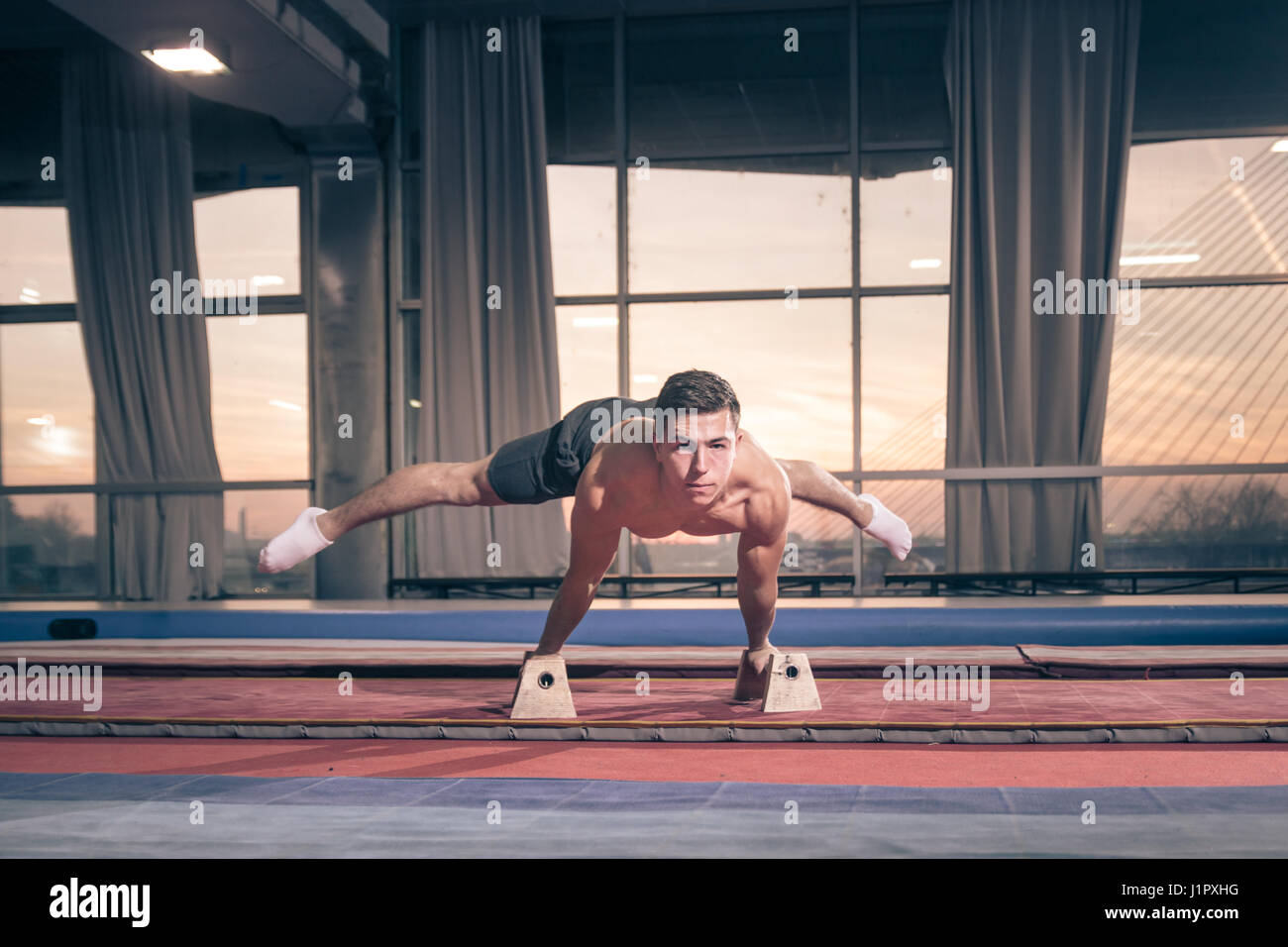young man, two hand cartwheel. sunset, indoors hall, windows Stock ...