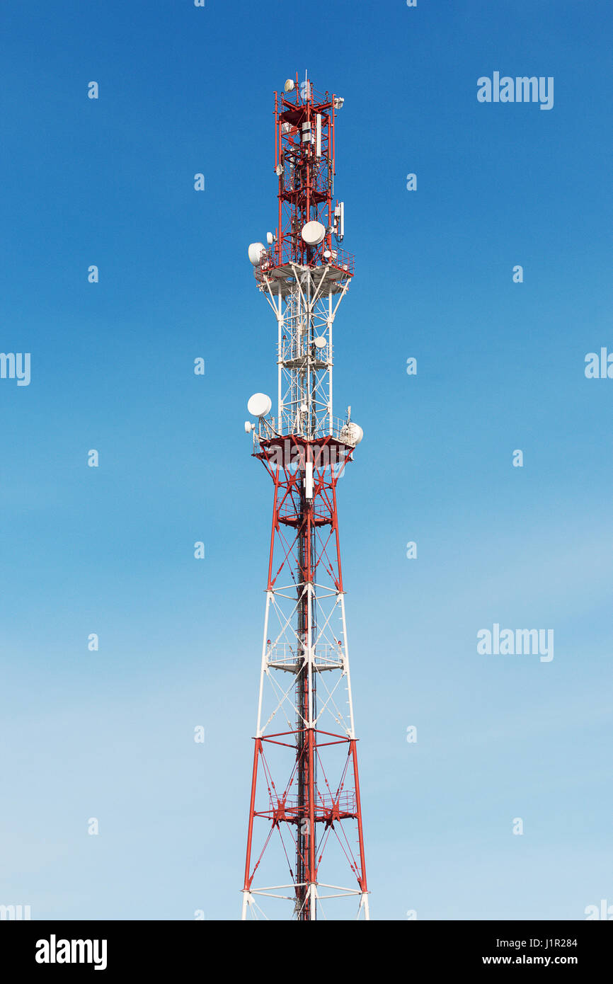 Cellular tower with antenna in red and white color Stock Photo - Alamy