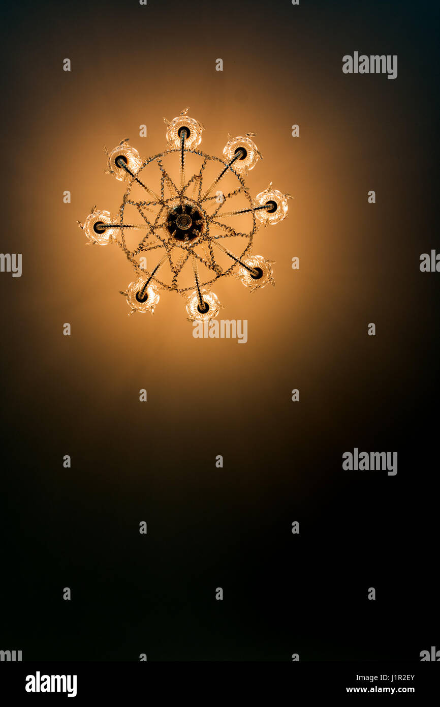 Bottom view electric ceiling lamp shines with yellow light Stock Photo ...