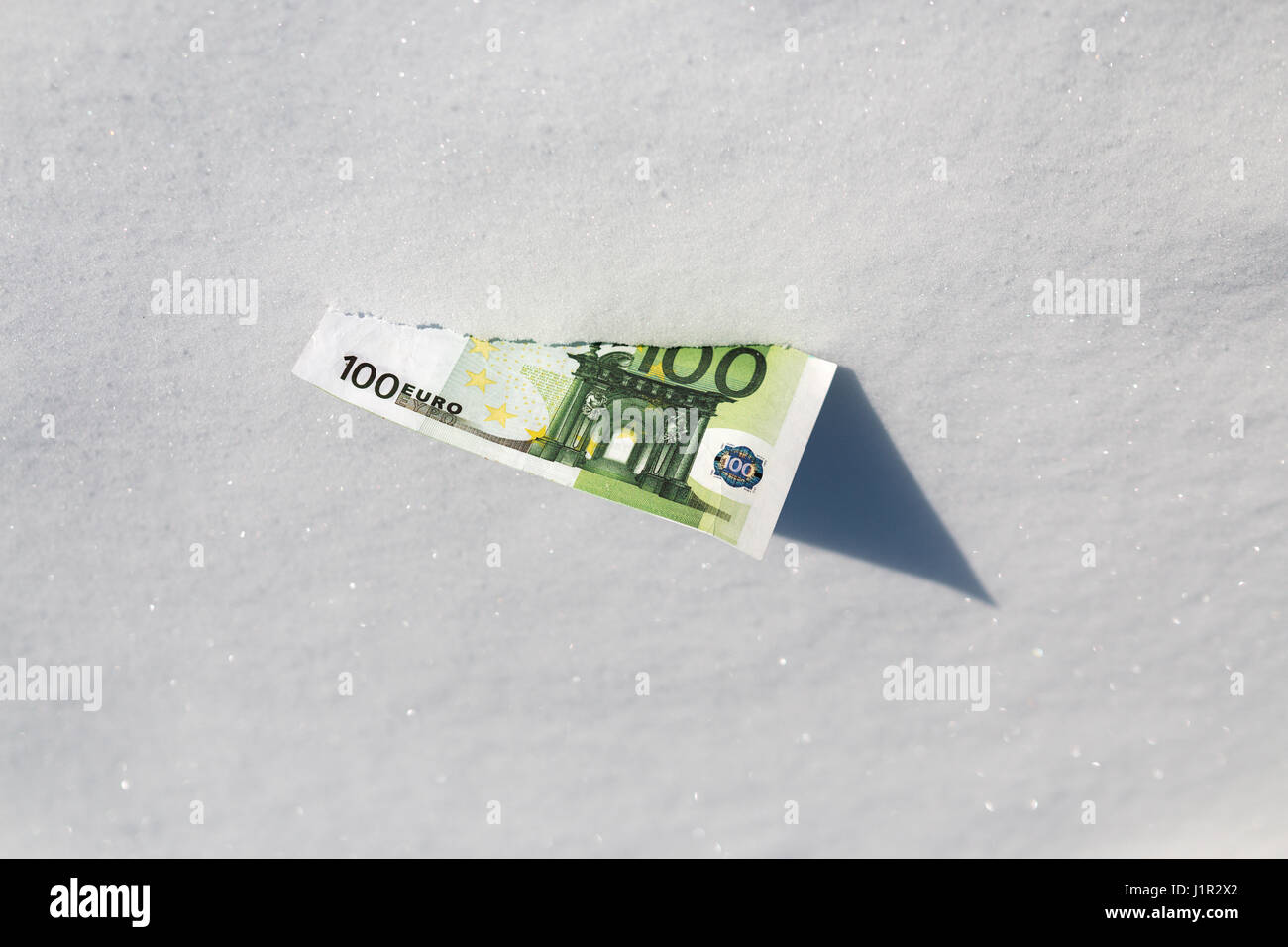 one hundred euro stuck in Snow White Stock Photo - Alamy