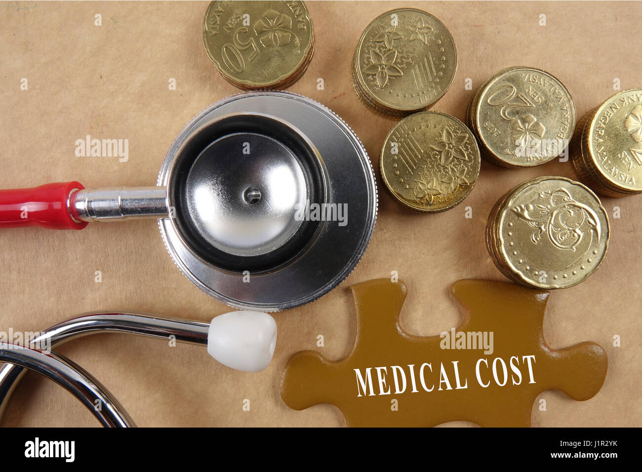 Medical concept with stethoscope,piece of puzzle and coins with HEALTH ...