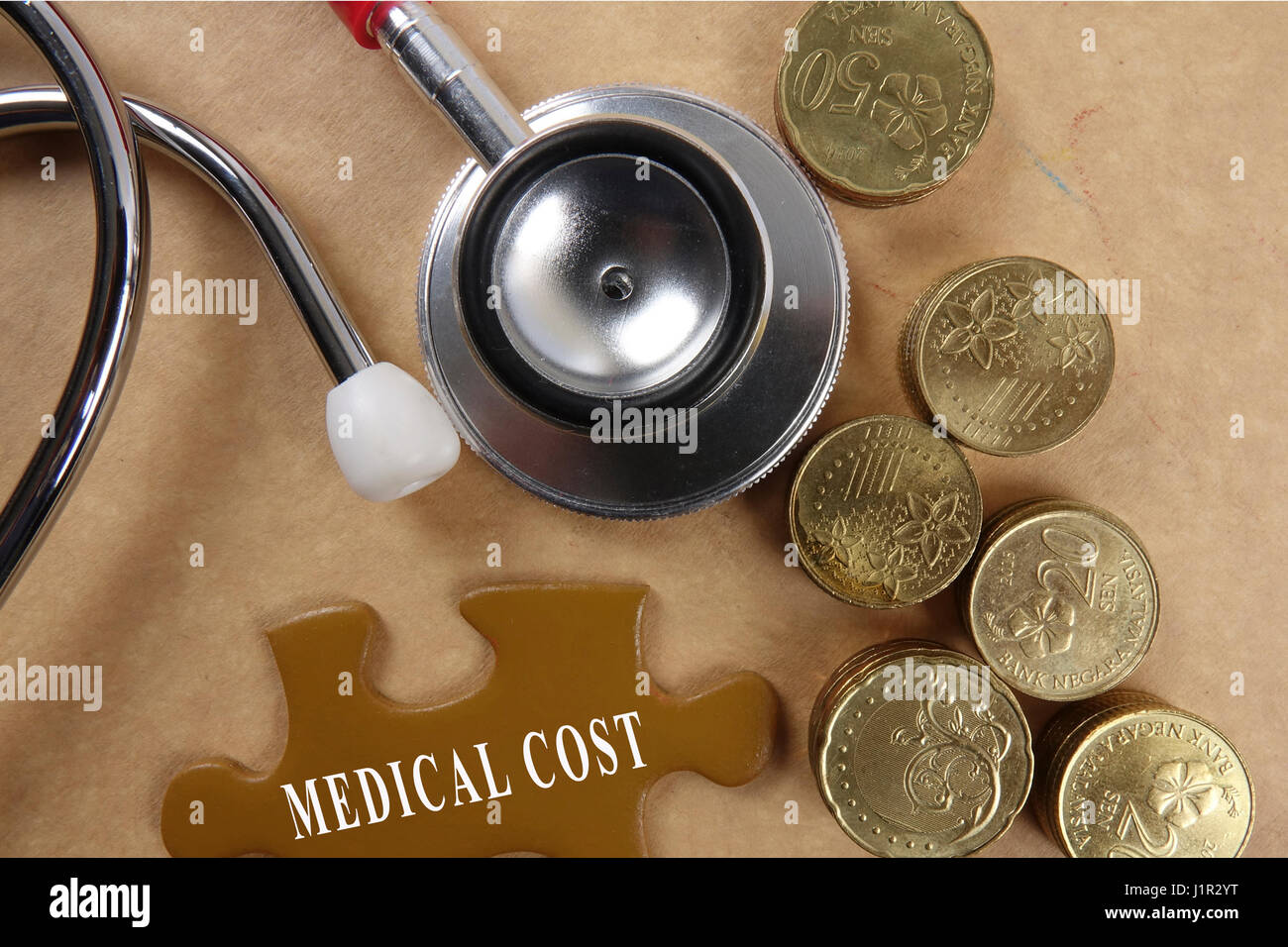 Medical concept with stethoscope,piece of puzzle and coins with HEALTH ...
