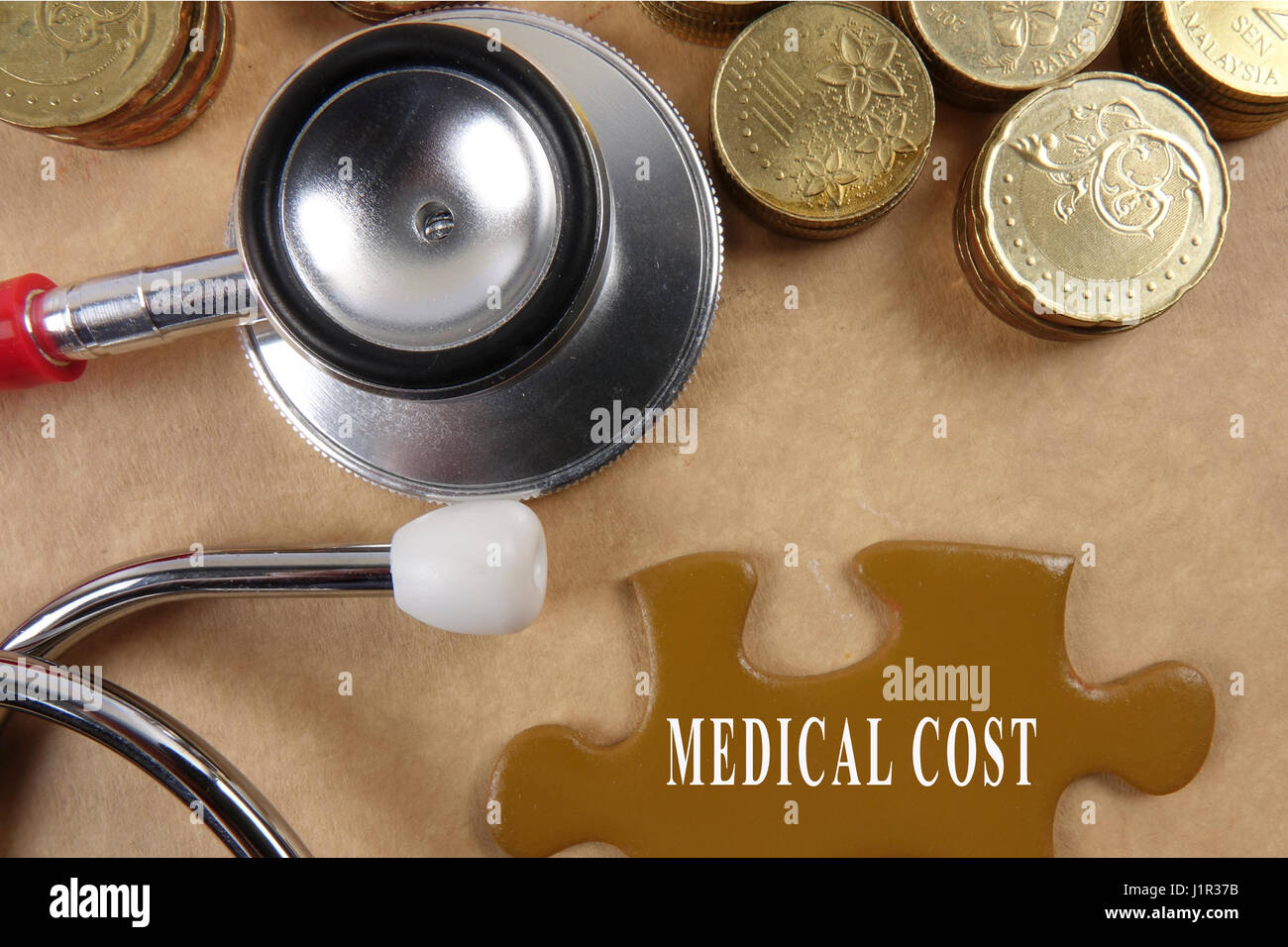 Medical concept with stethoscope,piece of puzzle and coins with HEALTH ...