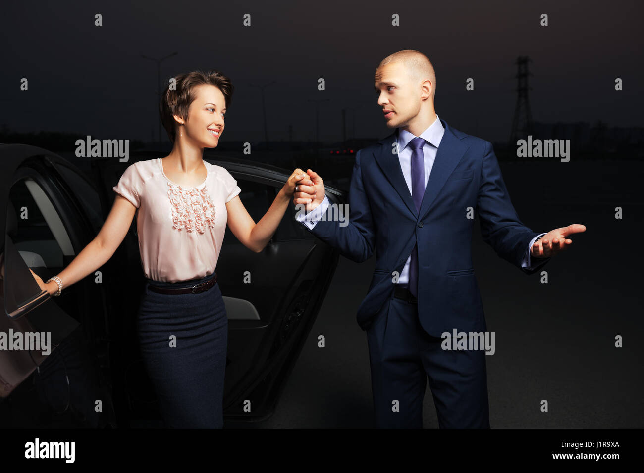Young business couple at the car Stock Photo - Alamy