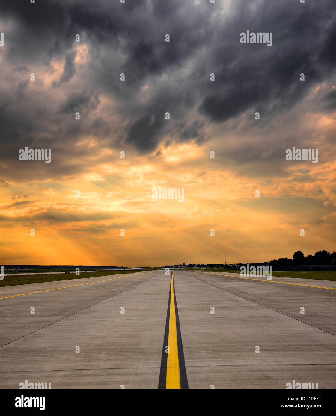 Empty airport runway with stormy sunset on the background Stock Photo ...