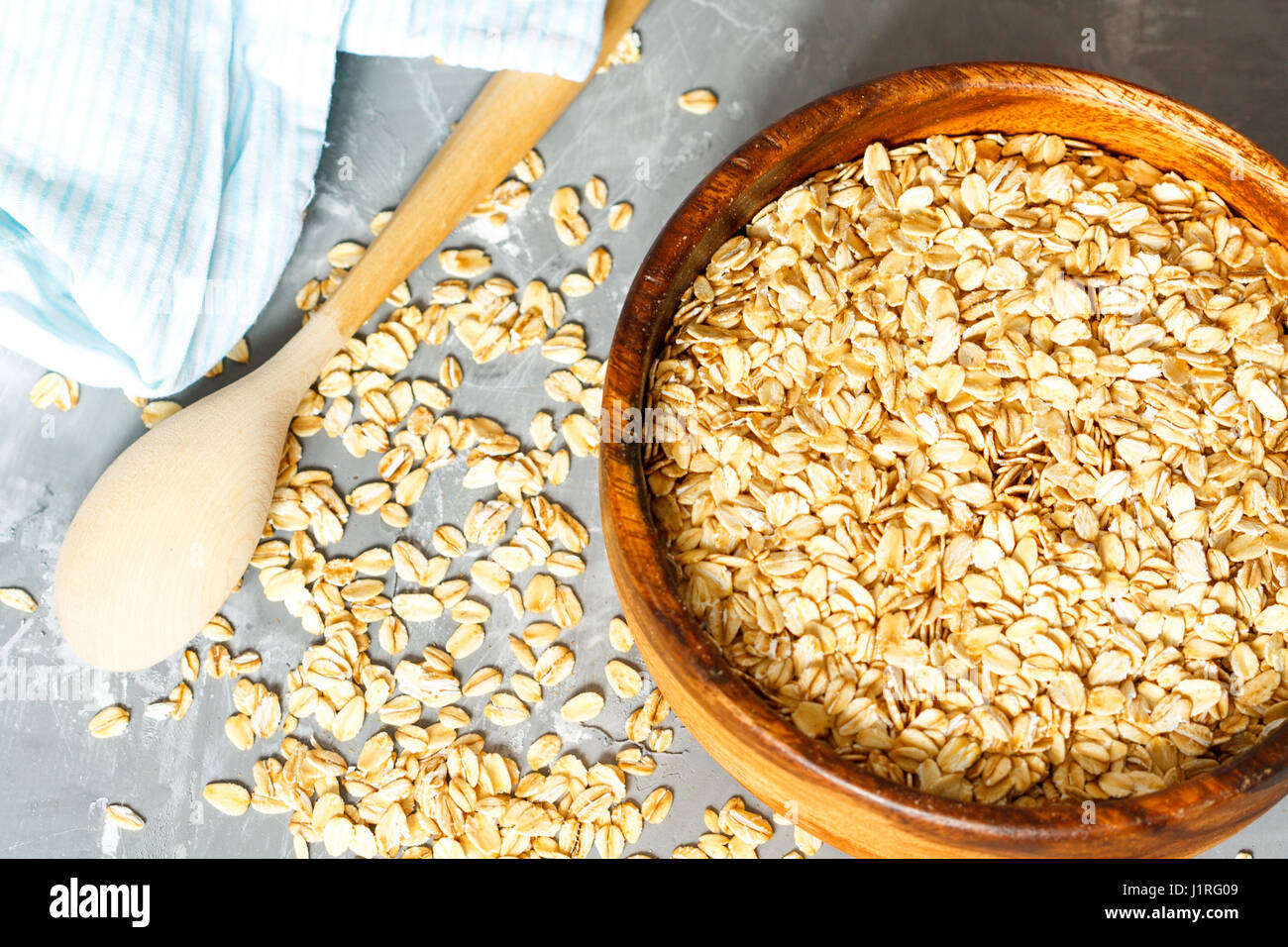 Raw oatmeal in a wooden bowl Stock Photo - Alamy