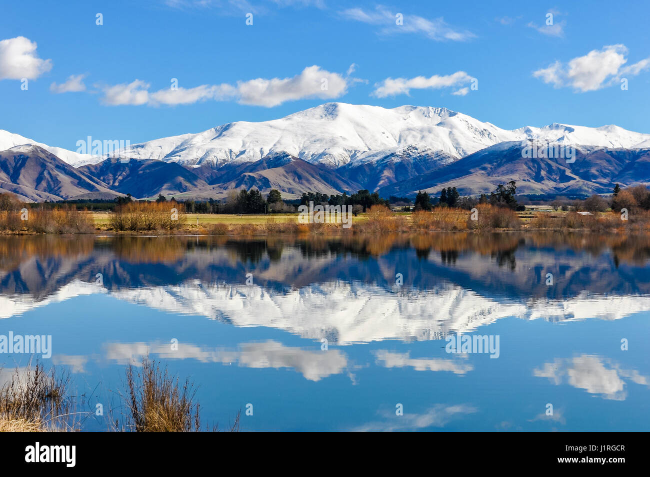 Reflection of the snowy mountains in a lake near Fairlie in the ...