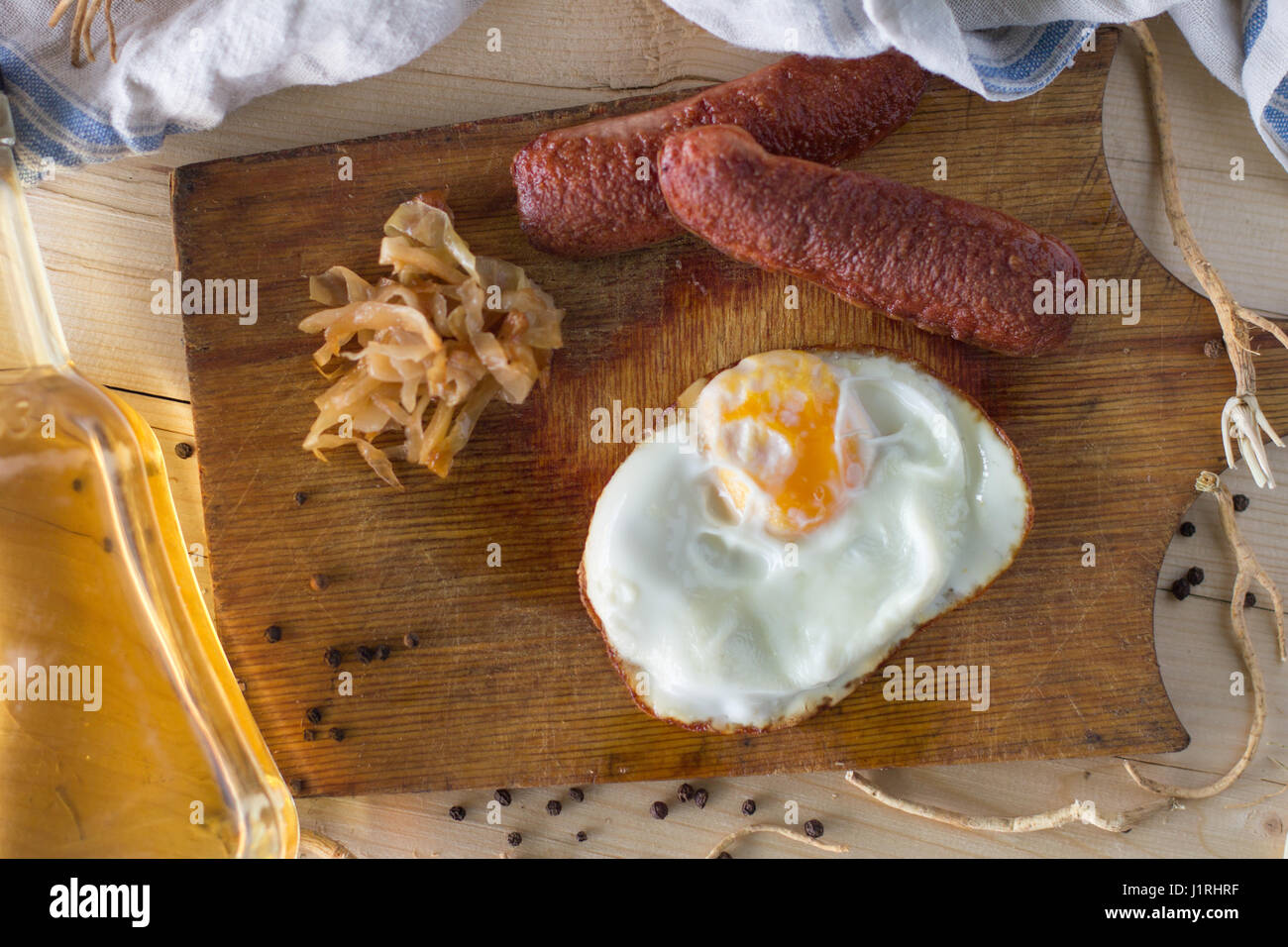 fried eggs with sausages and fried cabbage, rustic Stock Photo - Alamy