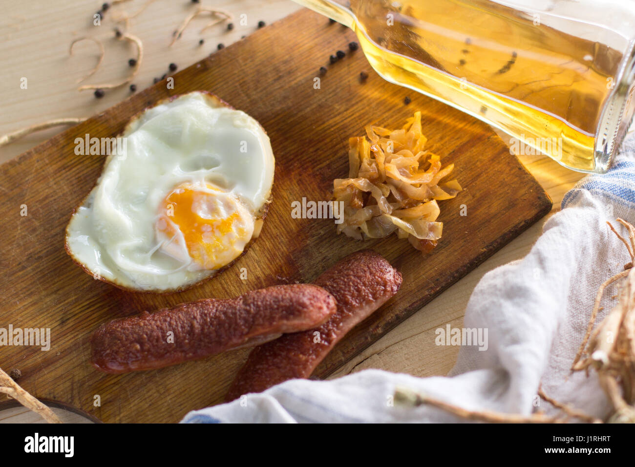 fried eggs with sausages and fried cabbage, rustic Stock Photo - Alamy