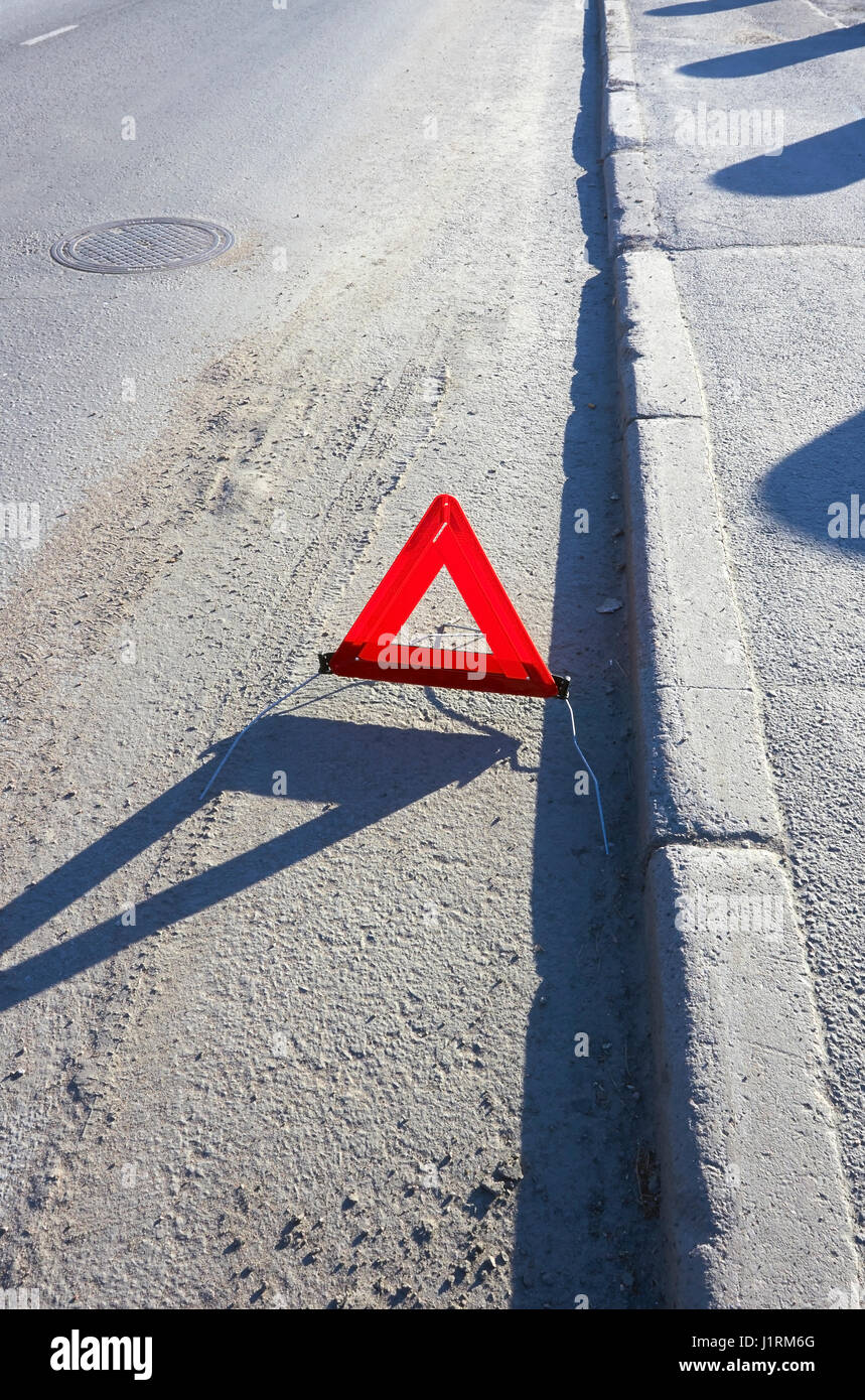 Red warning triangle on street Stock Photo - Alamy
