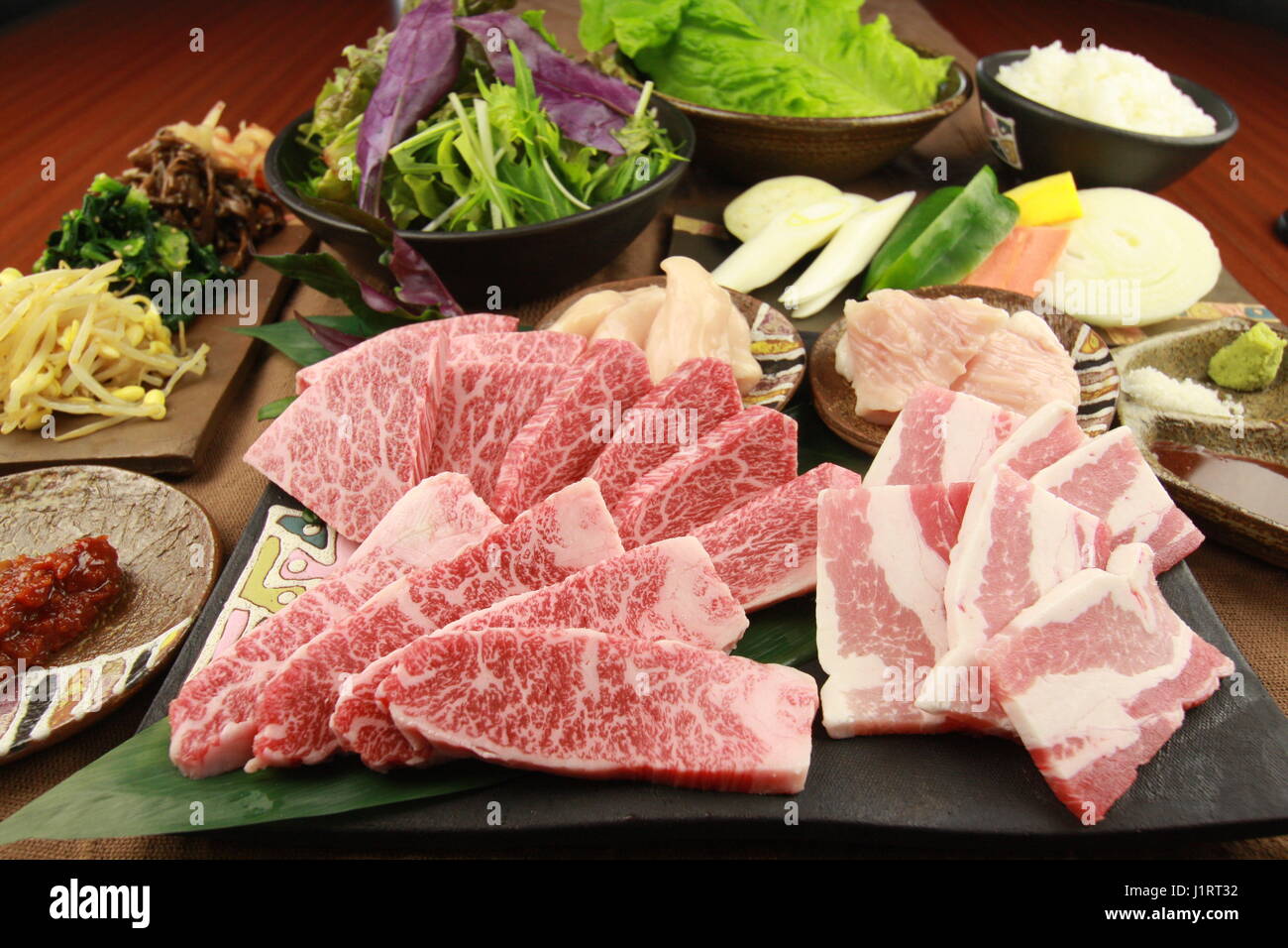 Fresh sliced beef with vegetables on tables in the kitchen Stock Photo ...