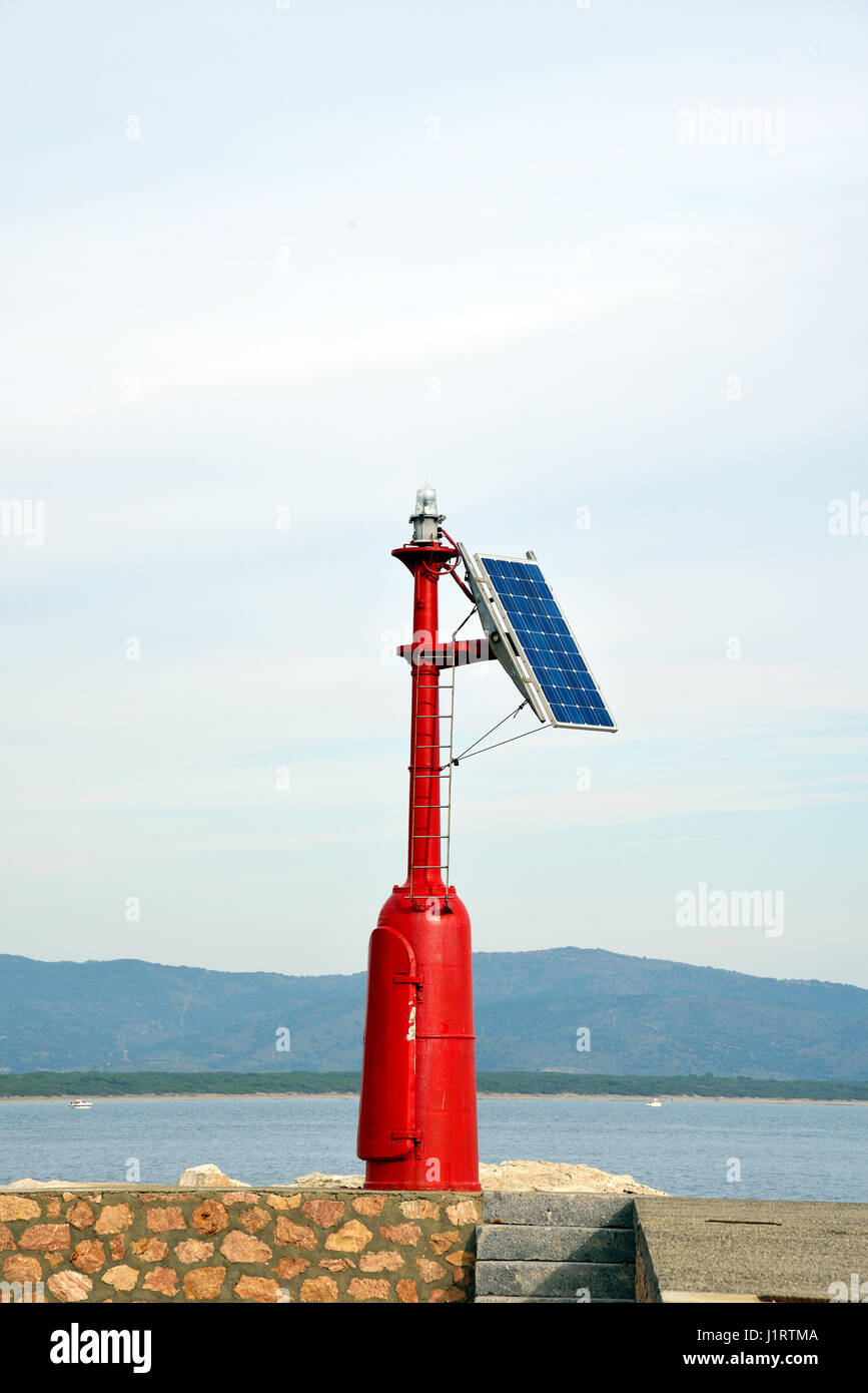 red lighthouse with solar panel in the harbor Stock Photo - Alamy
