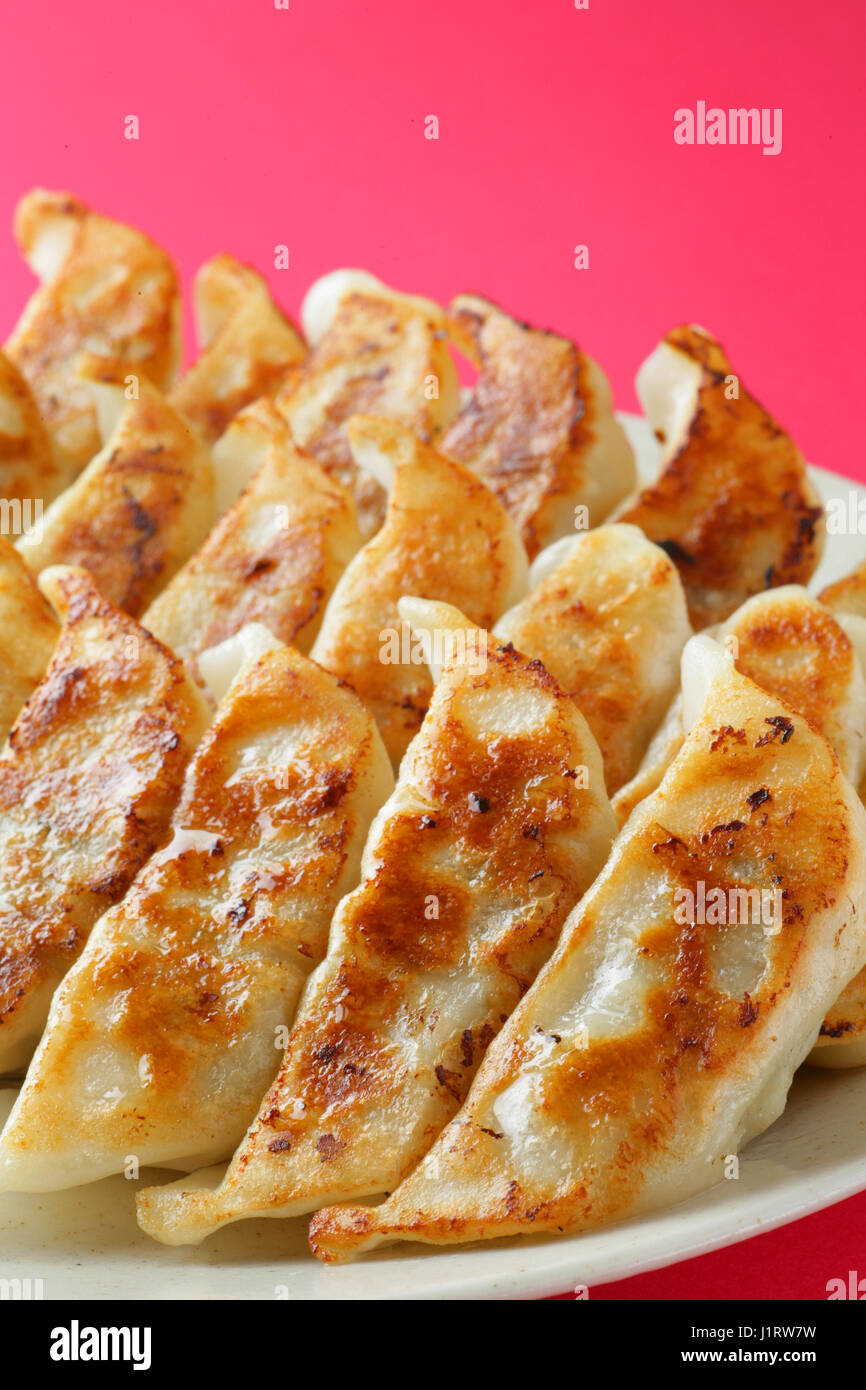Japanese dumplings on white dish Stock Photo - Alamy