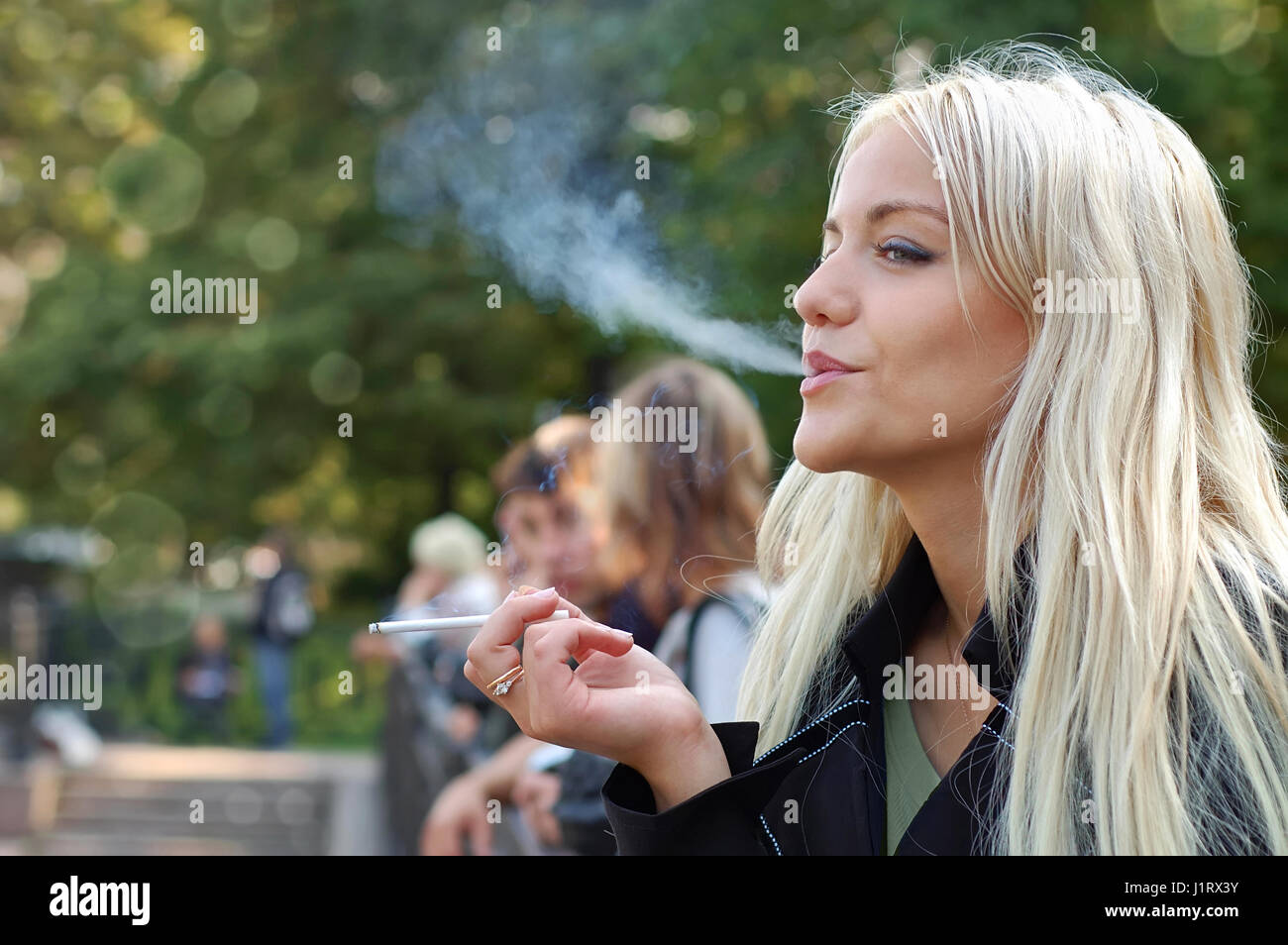Girl smoking outdoors Stock Photo - Alamy