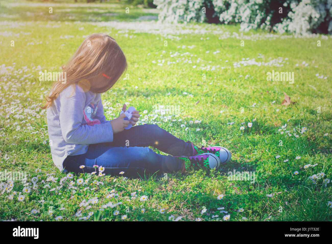 Little girl enjoys day in the park Stock Photo - Alamy
