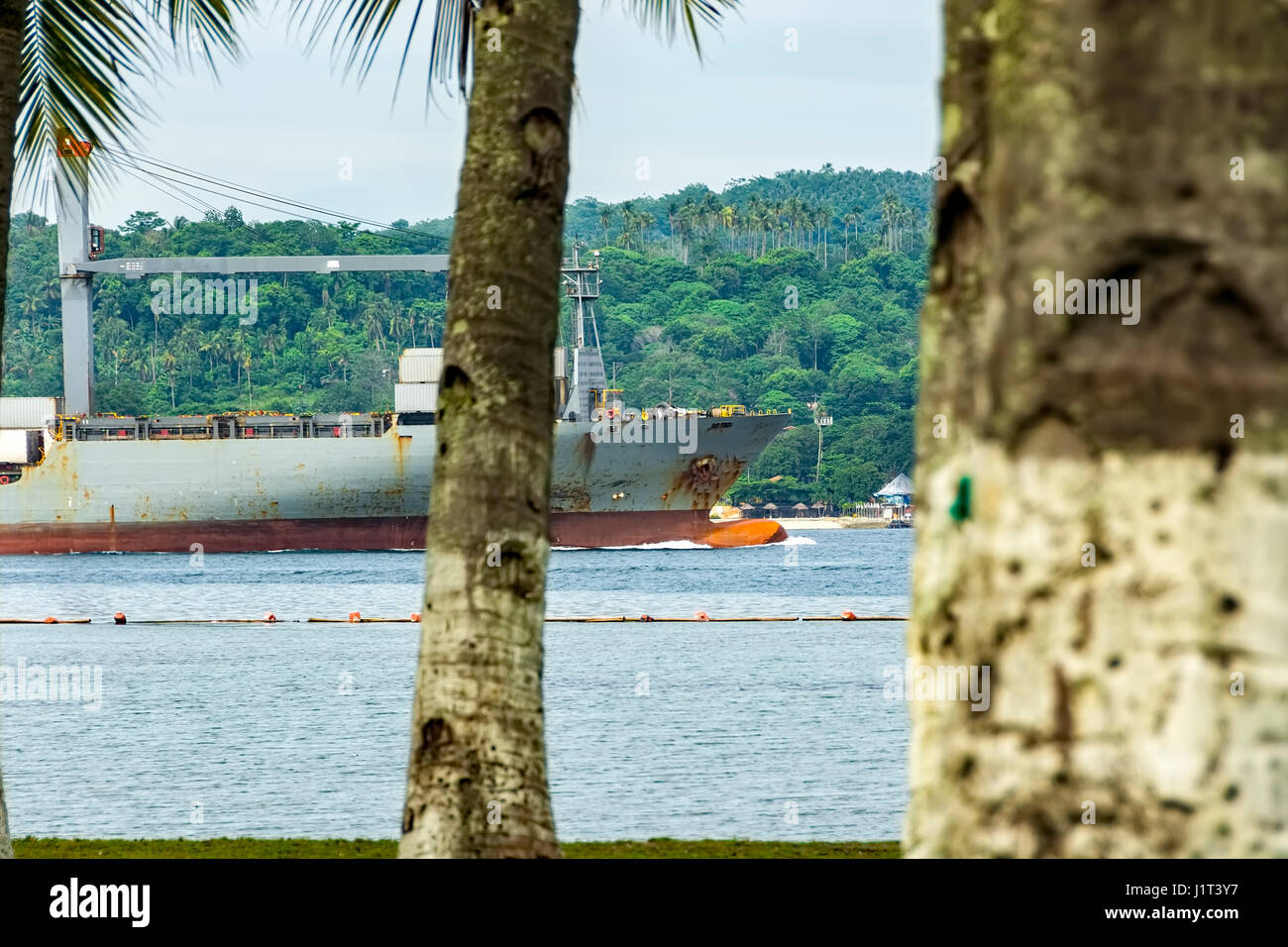 Container cargo ship passing thru canal, Philippines Stock Photo - Alamy
