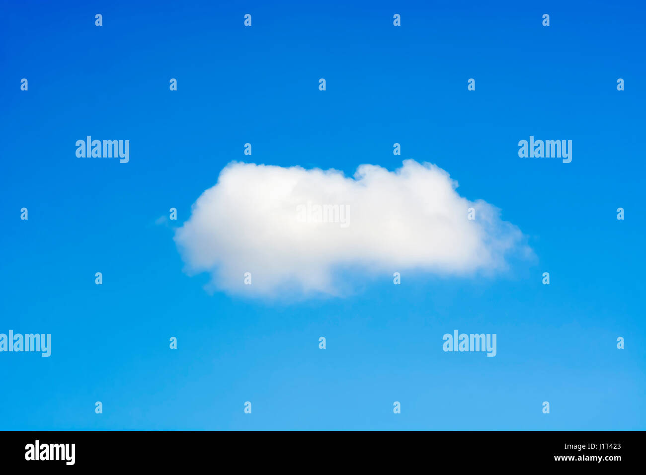Fluffy lone cloud against blue sky Stock Photo - Alamy