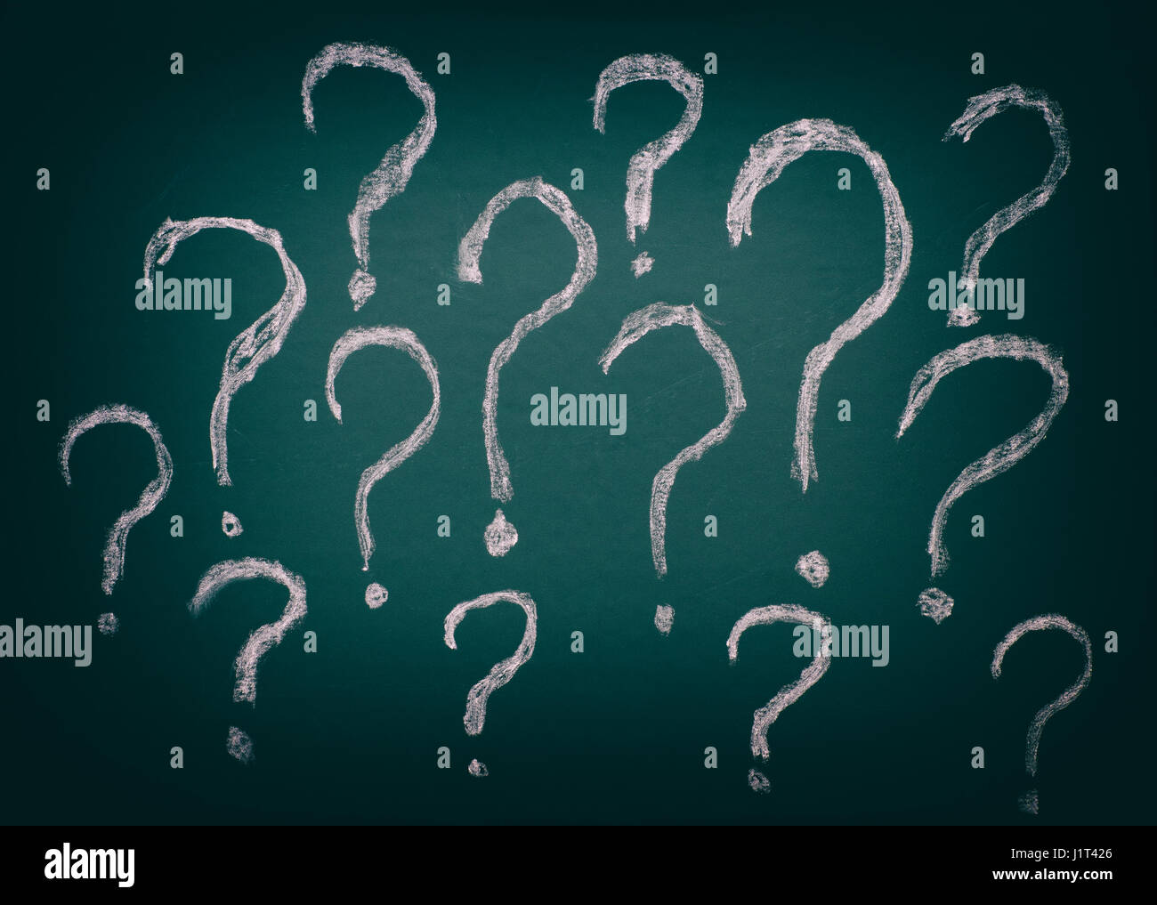 Question marks on chalkboard background. Close up Stock Photo - Alamy