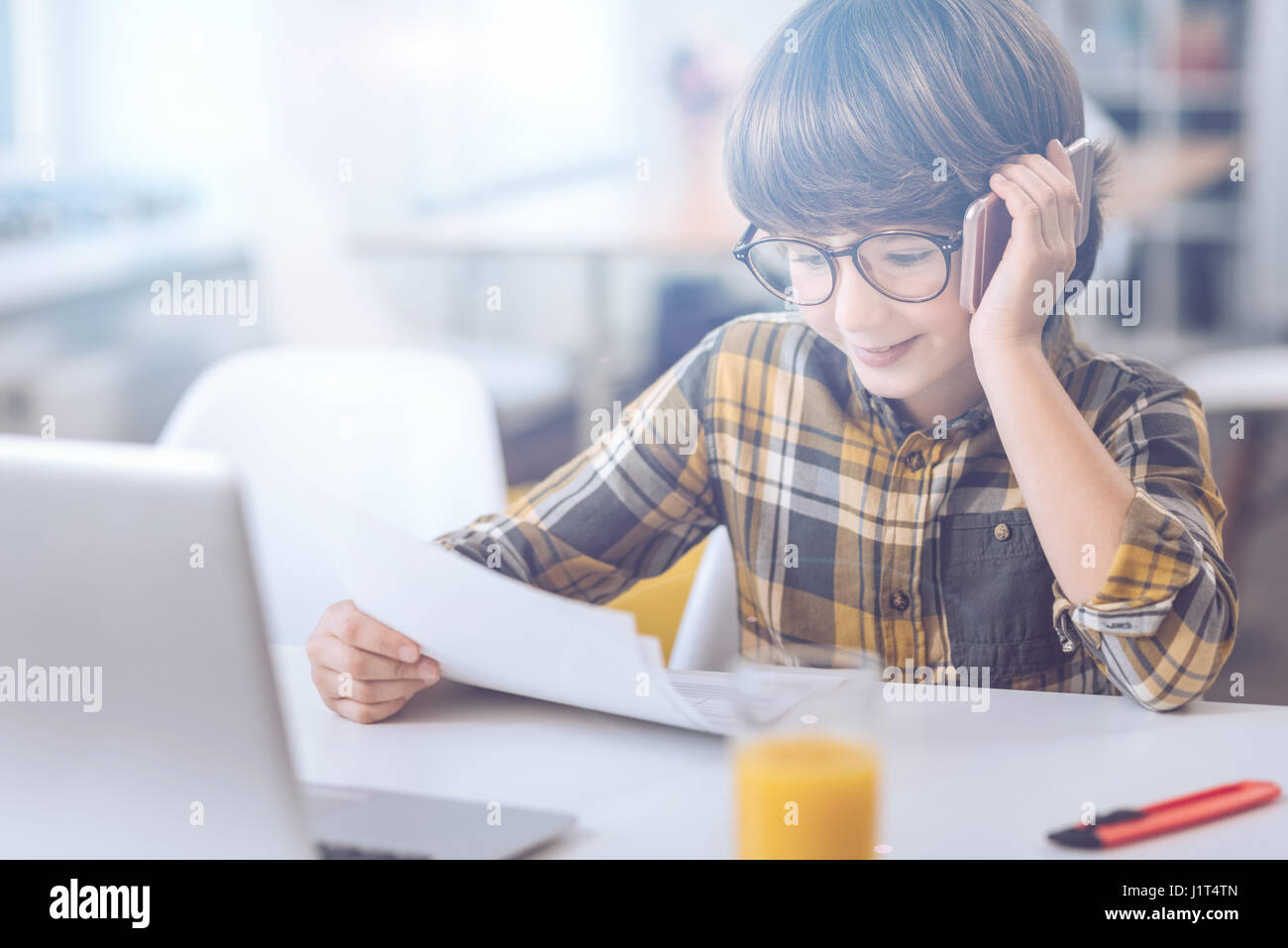 Smiling boy talking on phone with dad Stock Photo - Alamy