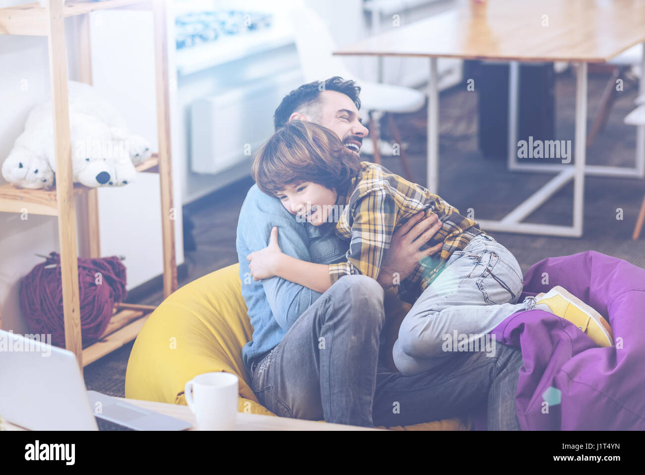Happy little boy flying into father's arms Stock Photo - Alamy