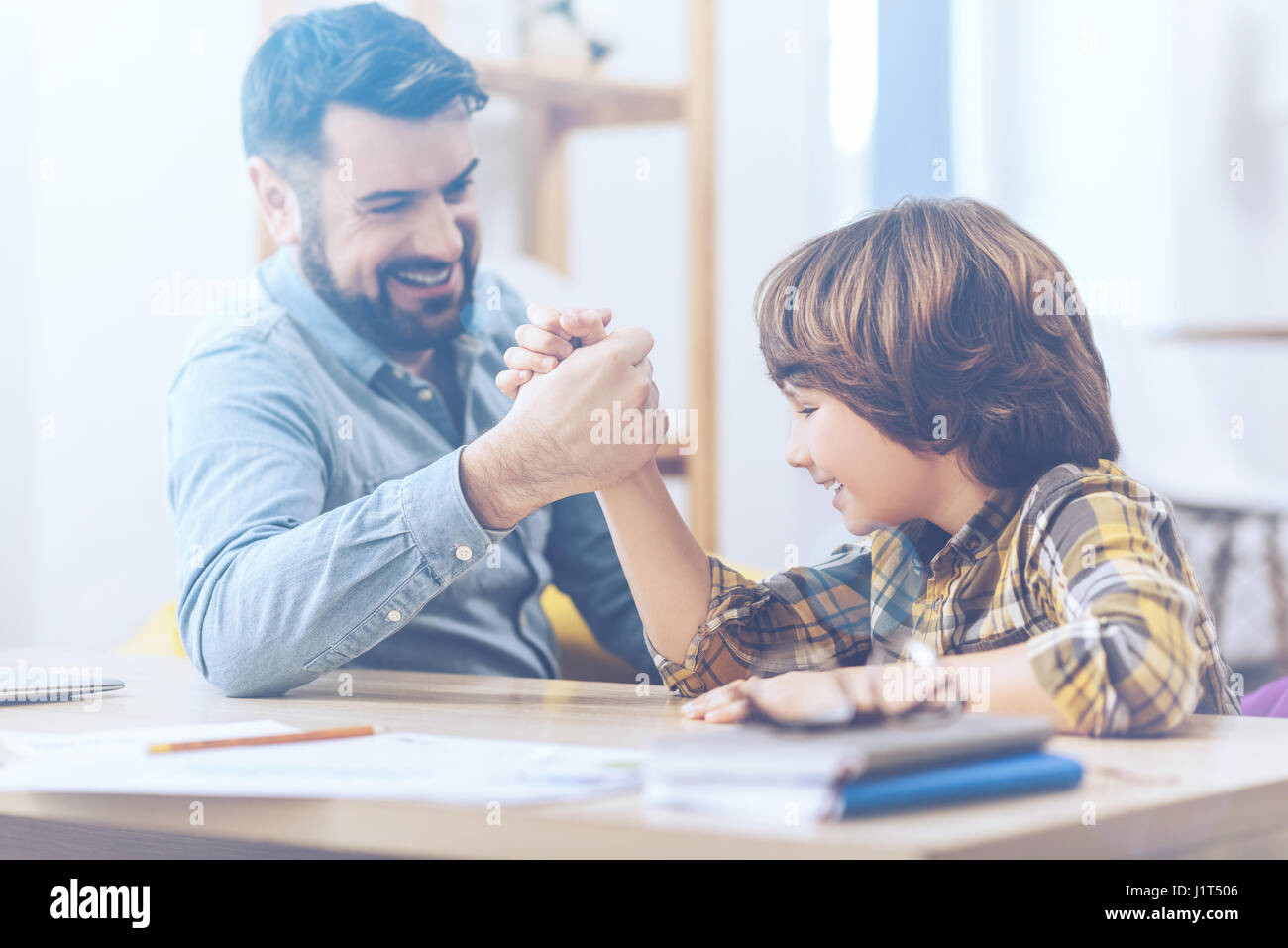 Two cute arm-wrestlers having fun Stock Photo - Alamy