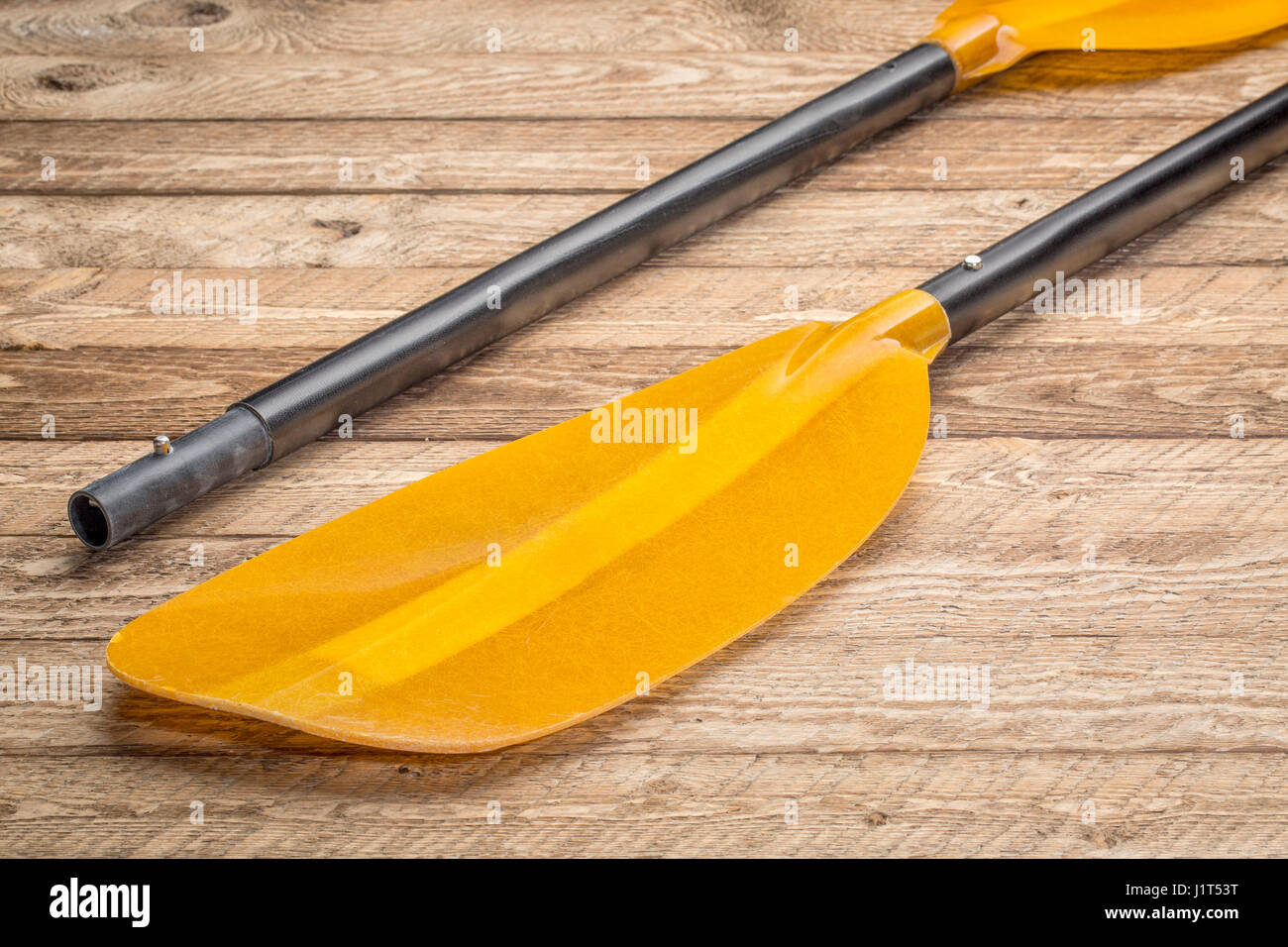 take-apart fiberglass whitewater kayak paddle against weathered wood ...