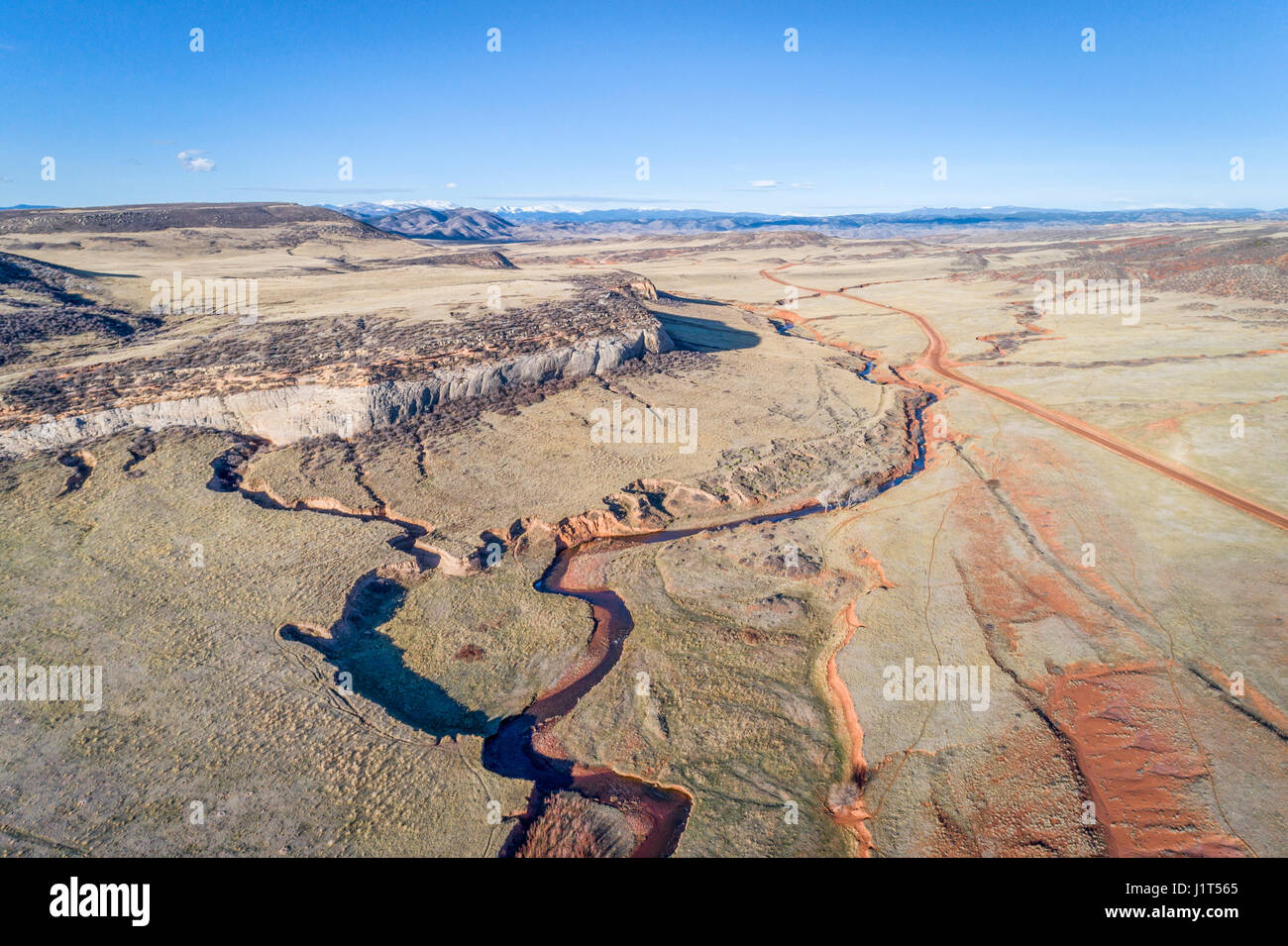 northern Colorado foothills aerial view with a creek, road and cattle ...