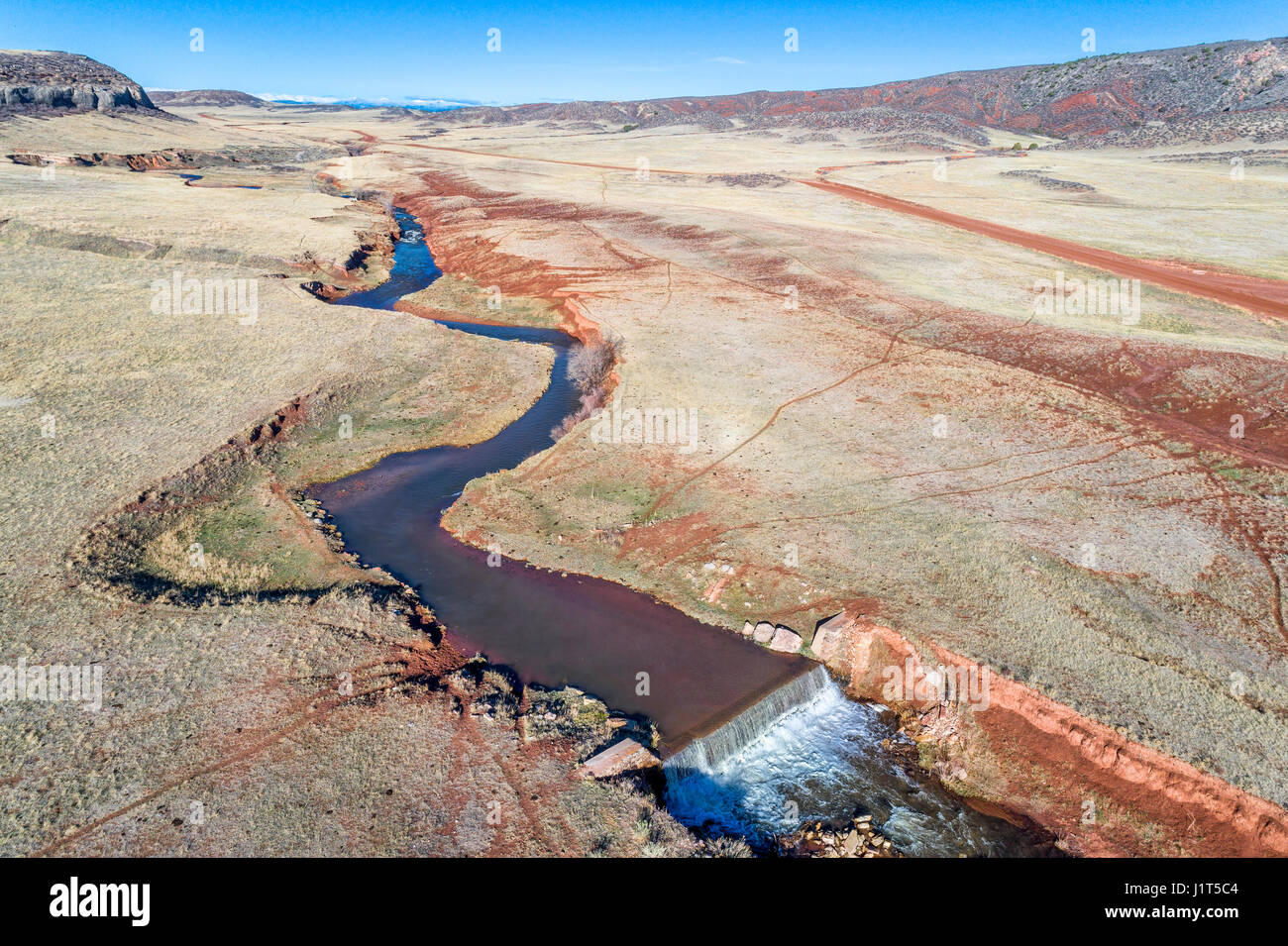 northern Colorado foothills aerial view with a creek, dam and cattle ...